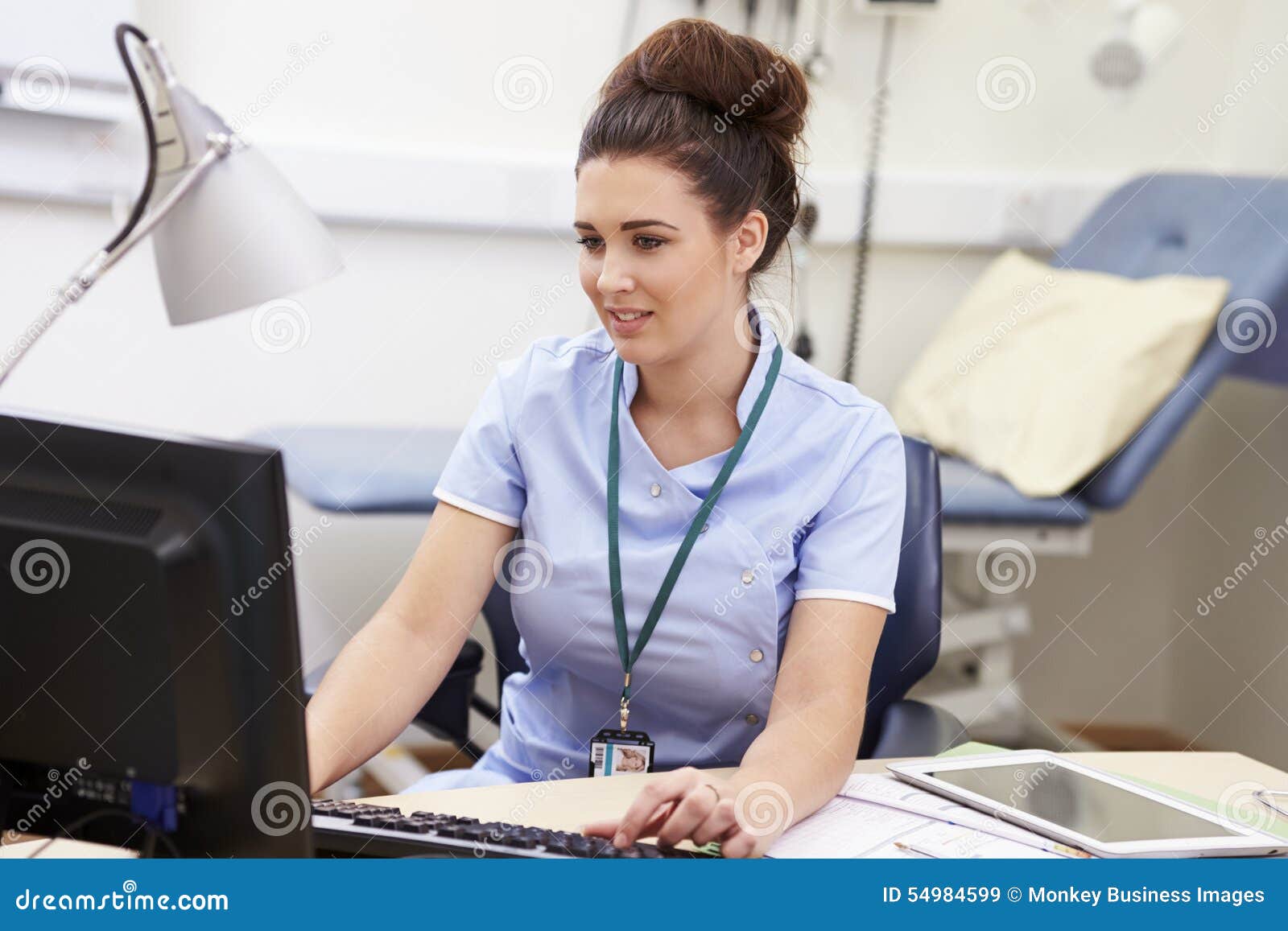 Female Nurse Working at Desk in Office Stock Image - Image of card ...