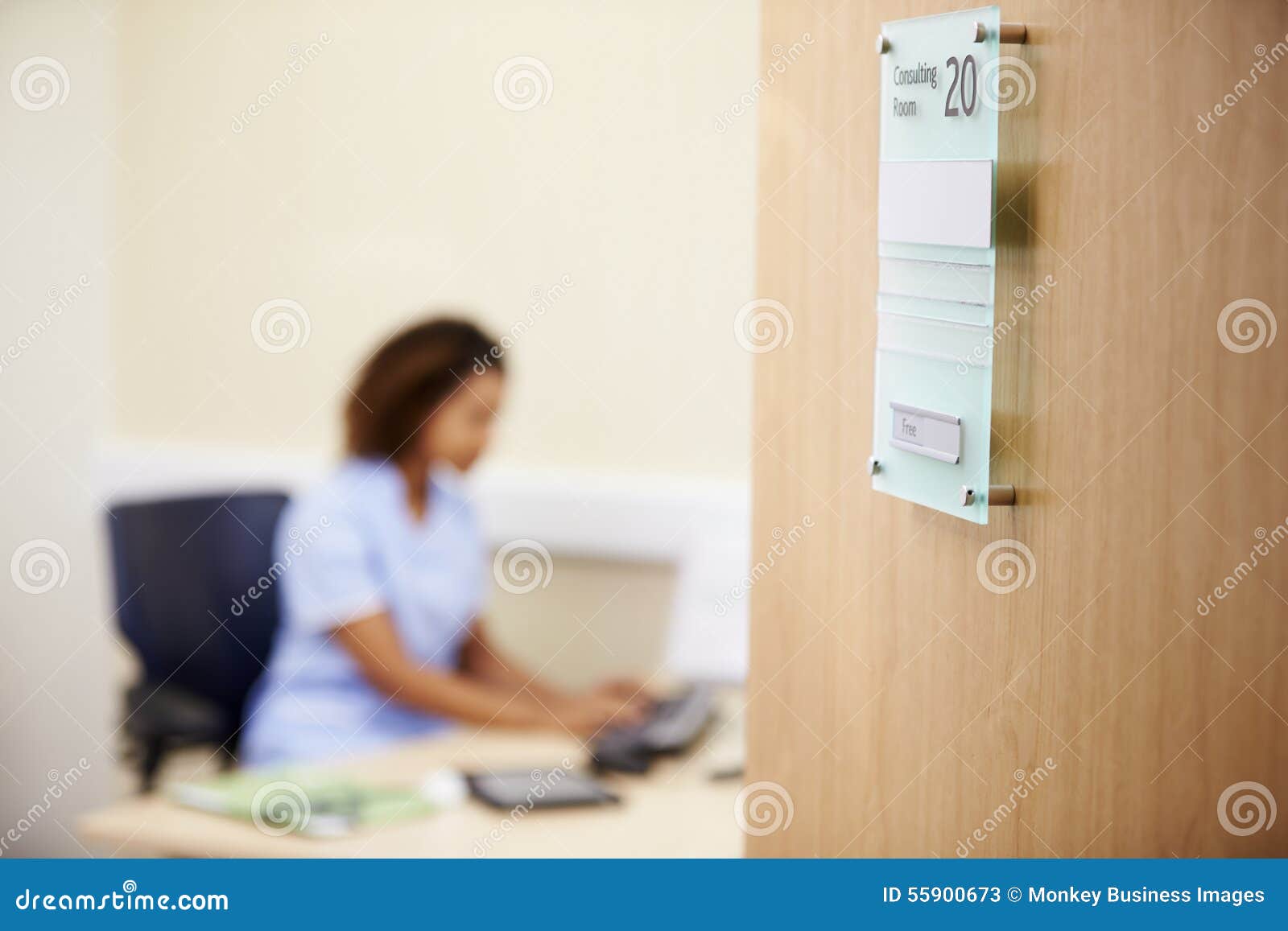 Female Nurse Working at Desk in Office Stock Image - Image of office ...
