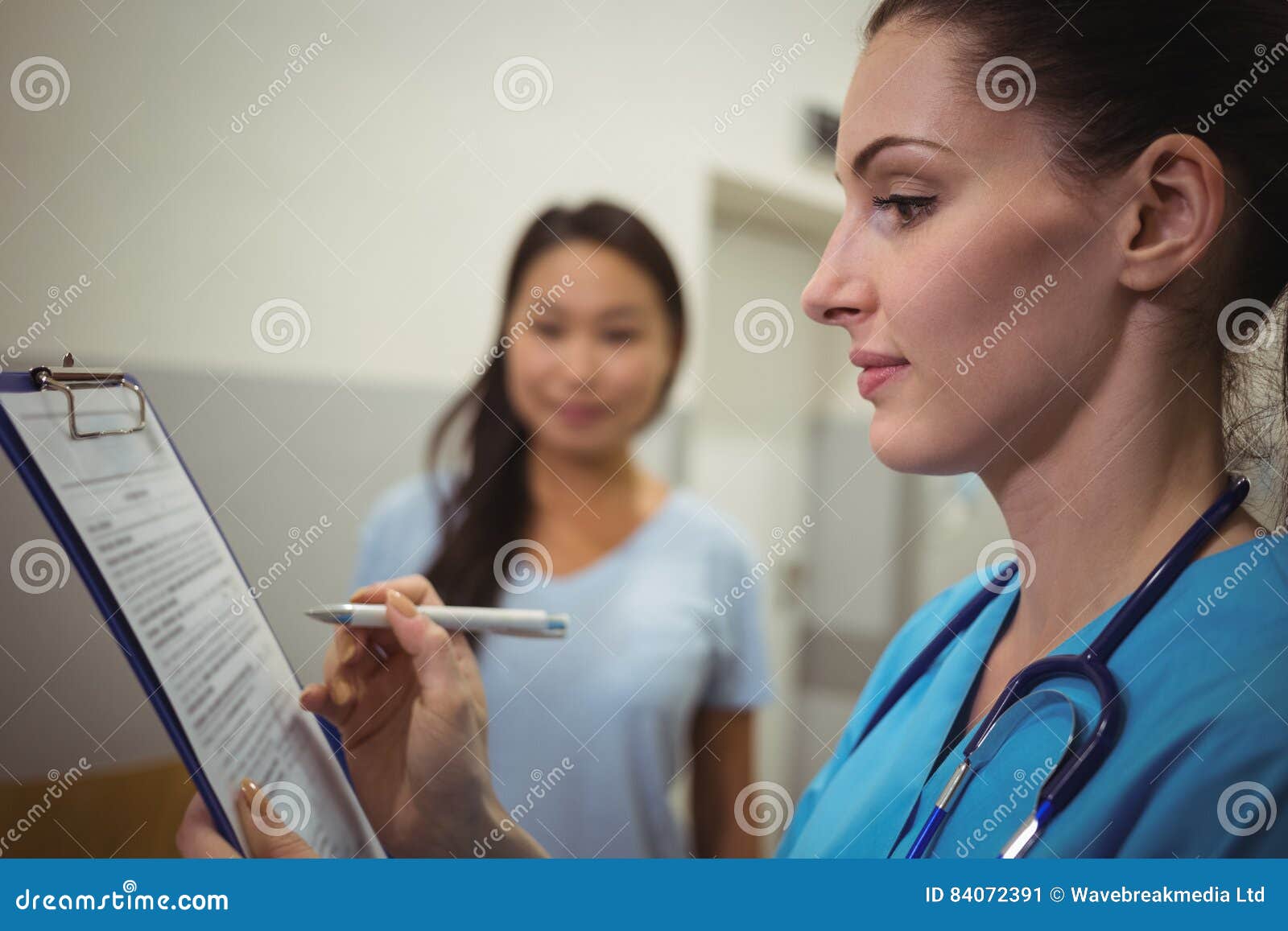 Female Nurse Writing on Clipboard Stock Image - Image of clinical ...
