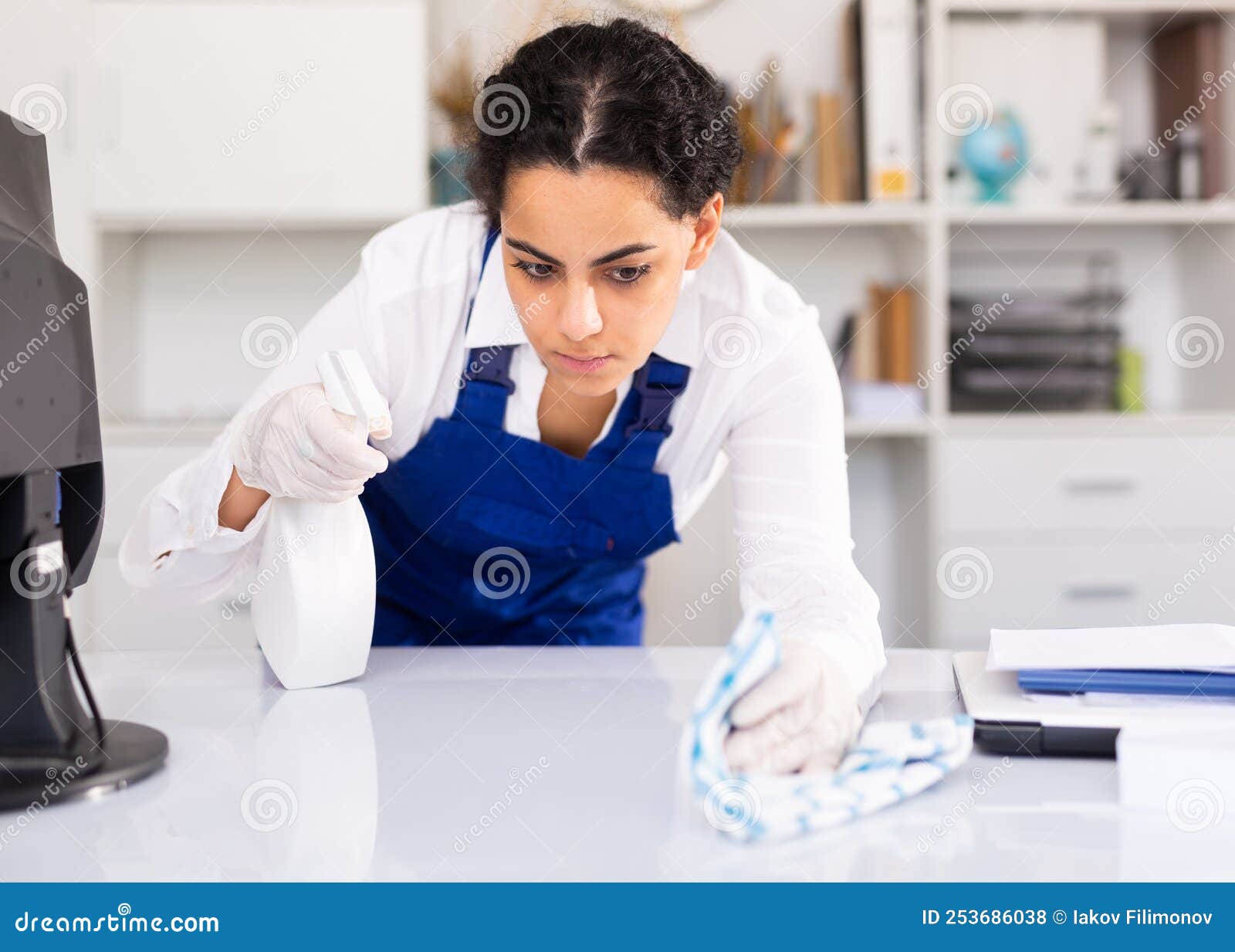 Female Office Cleaner is Cleaning Dust from the Desk in Office Stock ...