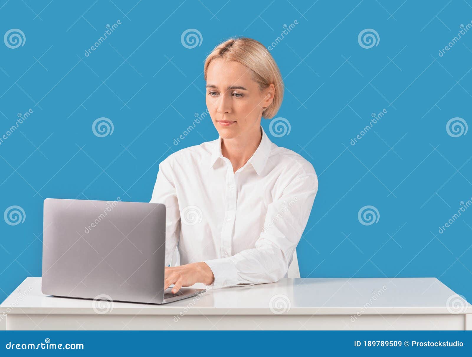 Female Office Worker Using Laptop Computer at Desk on Blue Background ...
