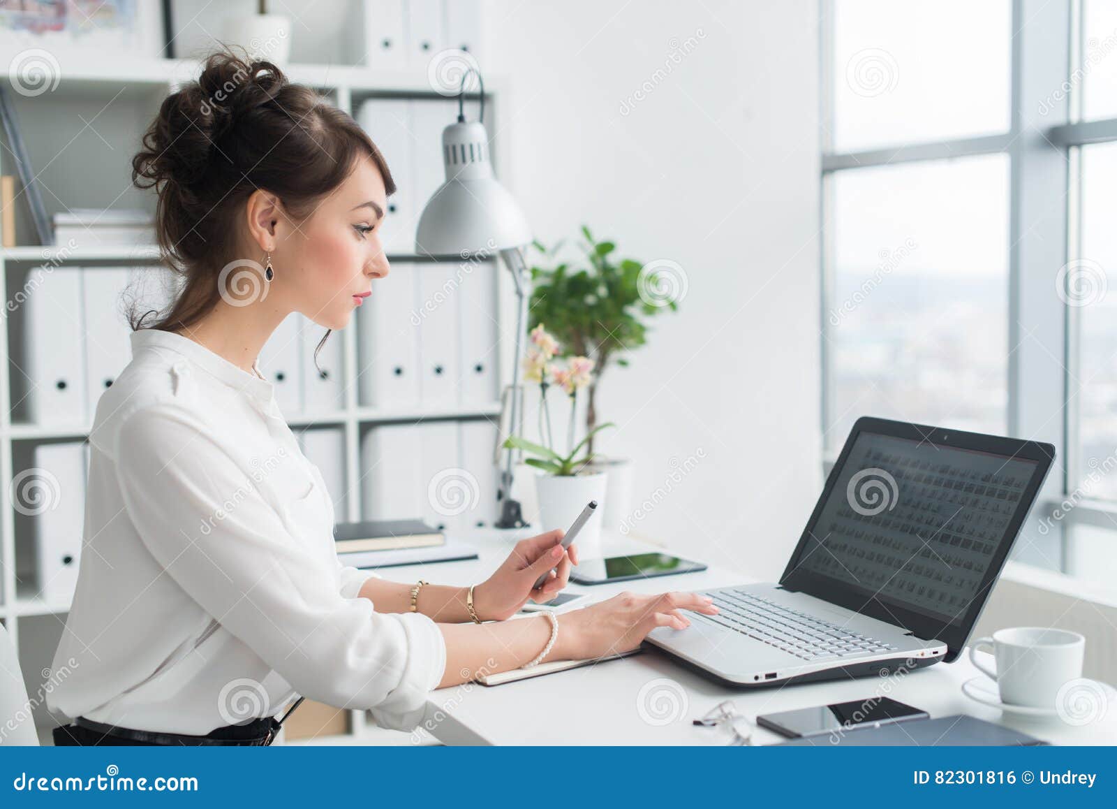 Female Office Worker Using Laptop at Her Workplace, Browsing ...