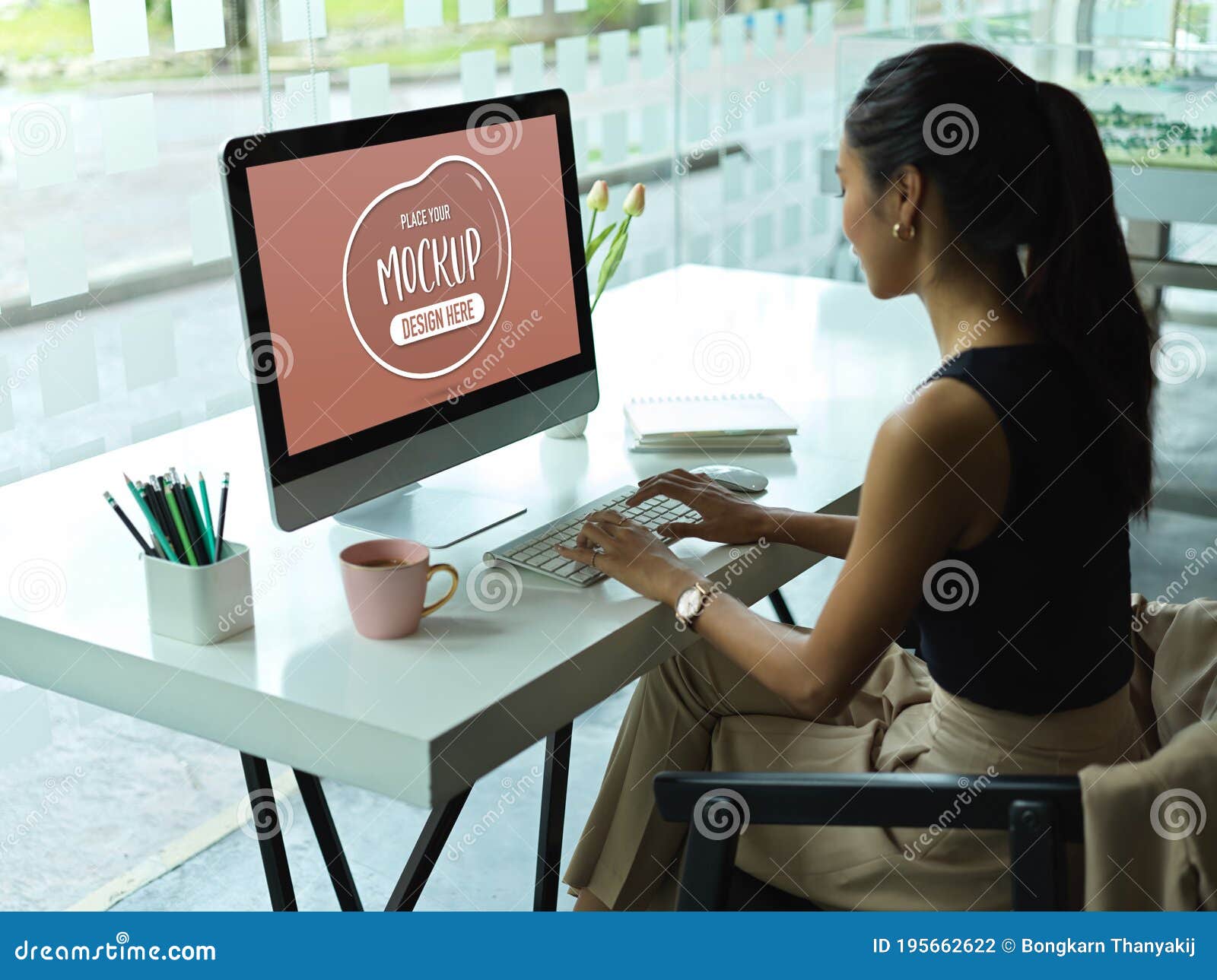 Female Office Worker Working on Mock Up Computer on Desk Stock Photo ...