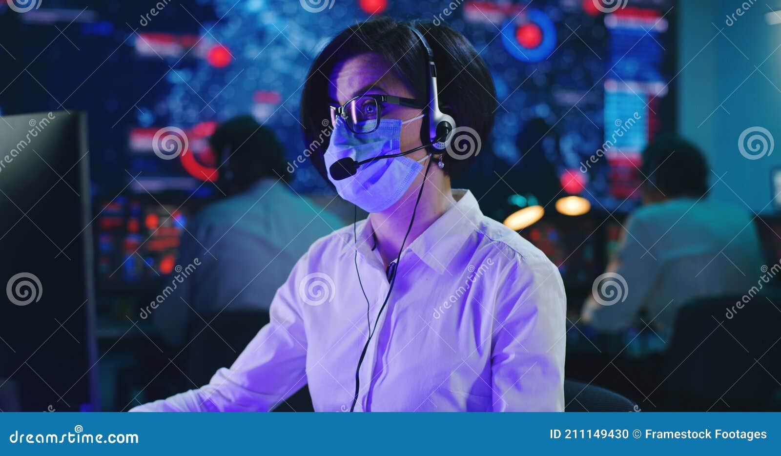 Female Operator in Mask Working in High Tech Security Center Stock ...