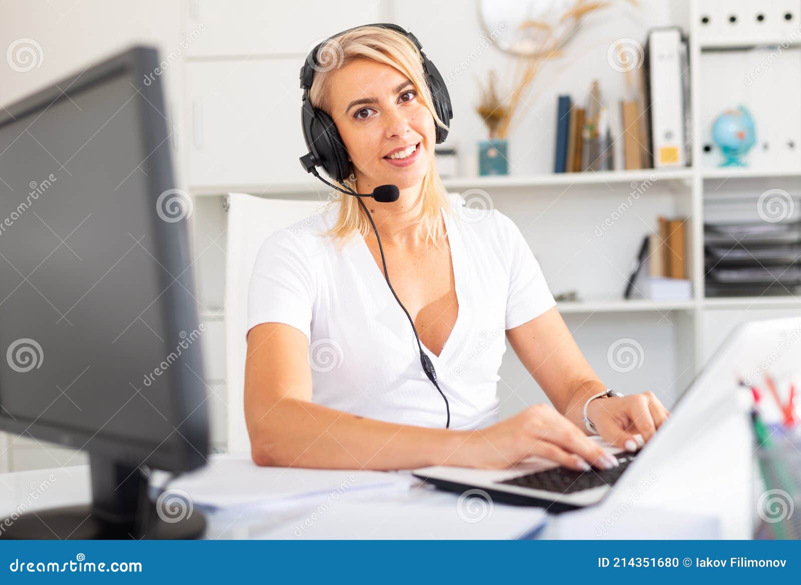 Female Operator Talking with Customer Using Headset at Company Office ...