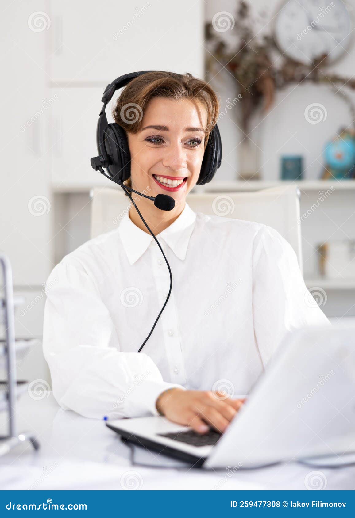 Female Operator Talking with Customer Using Headset at Company Office ...