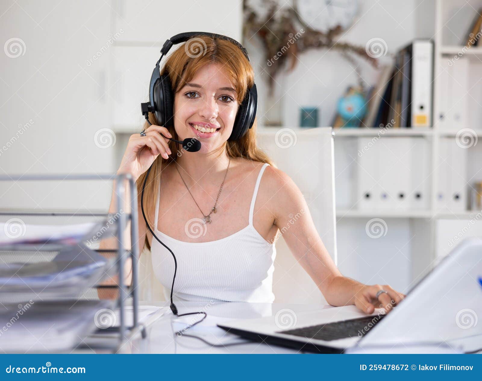 Female Operator Talking with Customer Using Headset at Company Office ...