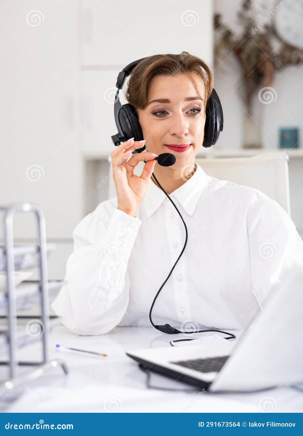 Female Operator Talking with Customer Using Headset at Company Office ...