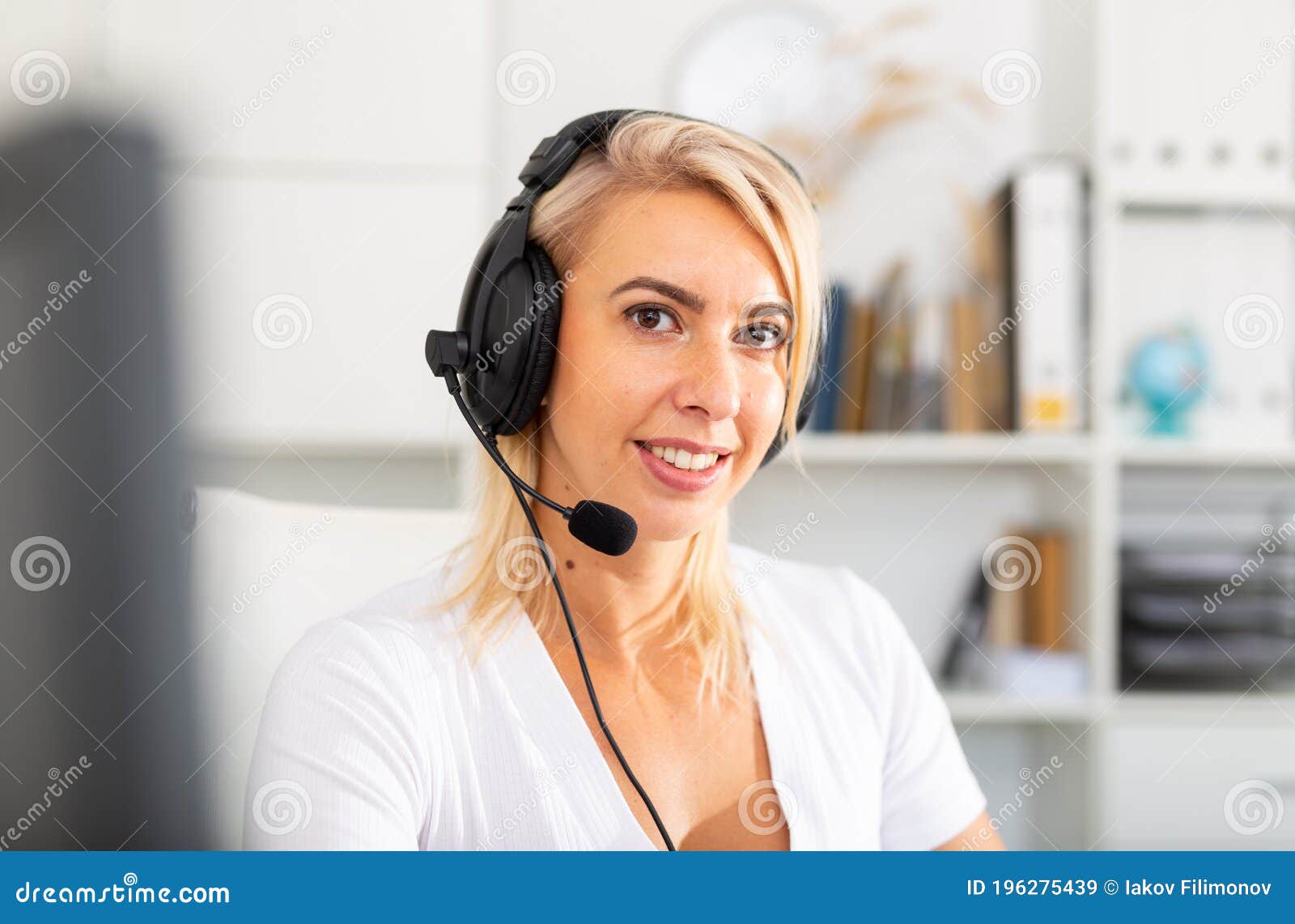 Female Operator Talking with Customer Using Headset at Company Office ...