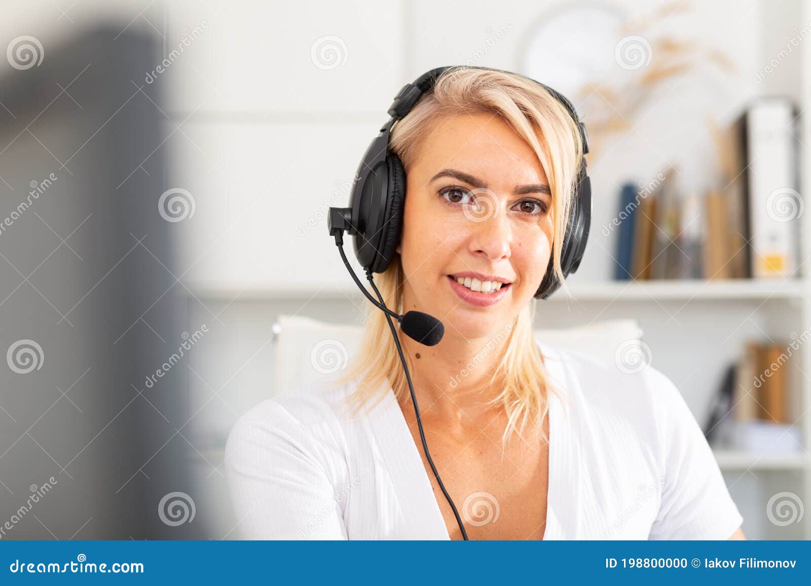 Female Operator Talking with Customer Using Headset at Company Office ...