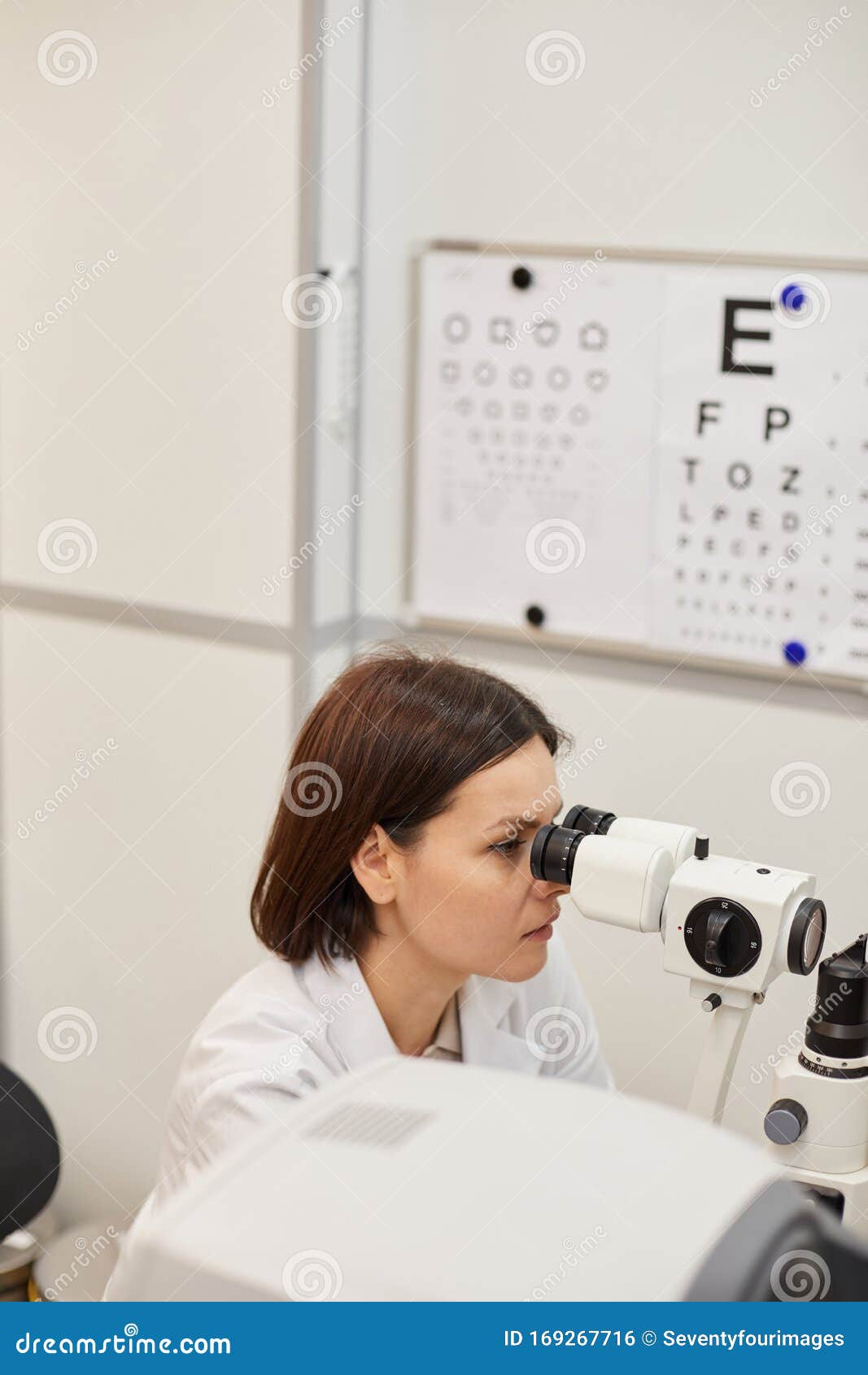 Female Ophthalmologist Using Vision Test Machine Stock Photo - Image of ...
