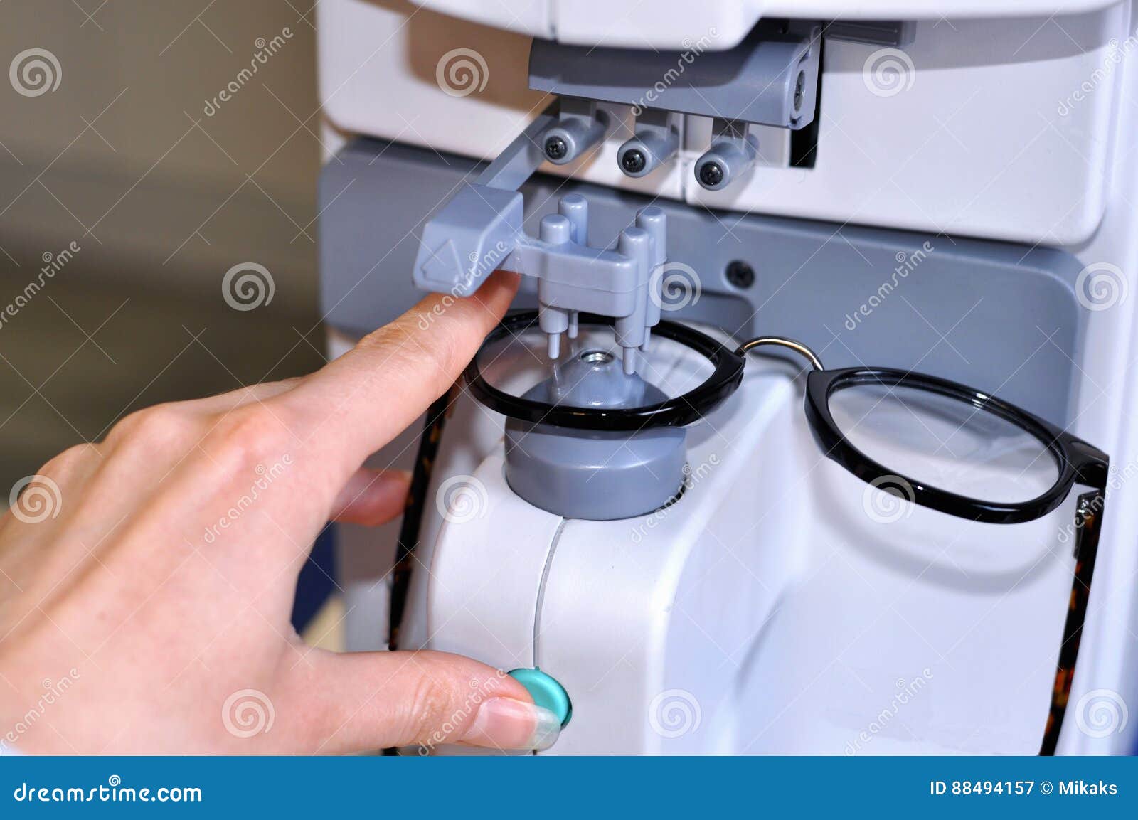 Female Optician Measuring and Preparing Glasses on the Digital Device ...