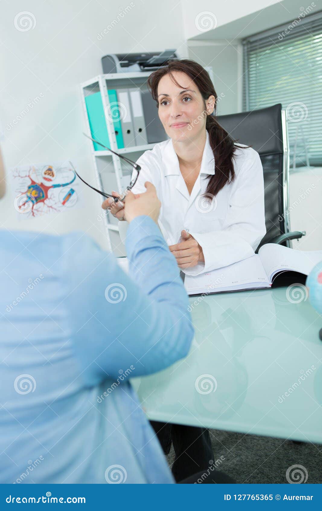 Female Optician Offering Glasses Frames To Customer Stock Image - Image ...