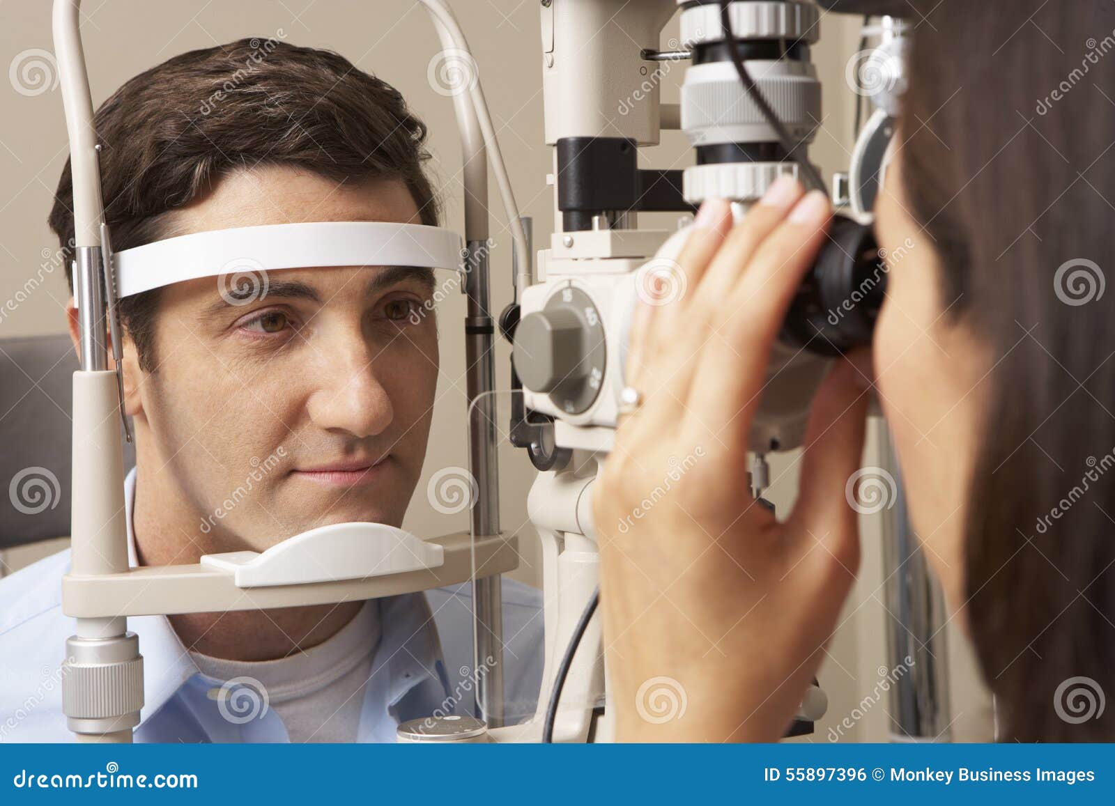 Female Optician in Surgery Giving Man Eye Test Stock Photo - Image of ...