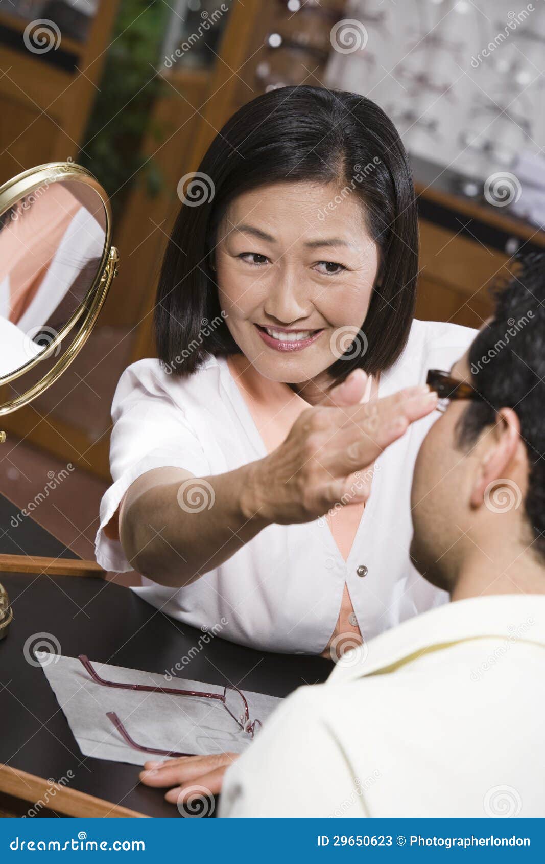 Female Optometrist Assisting Patient in Choosing Spectacles Stock Image ...