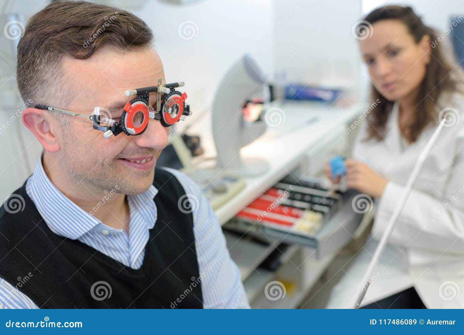 Female Optometrist Examining Smiling Patient Stock Image - Image of ... Female Optometrist Examining Smiling Patient Stock Image - Image of ...