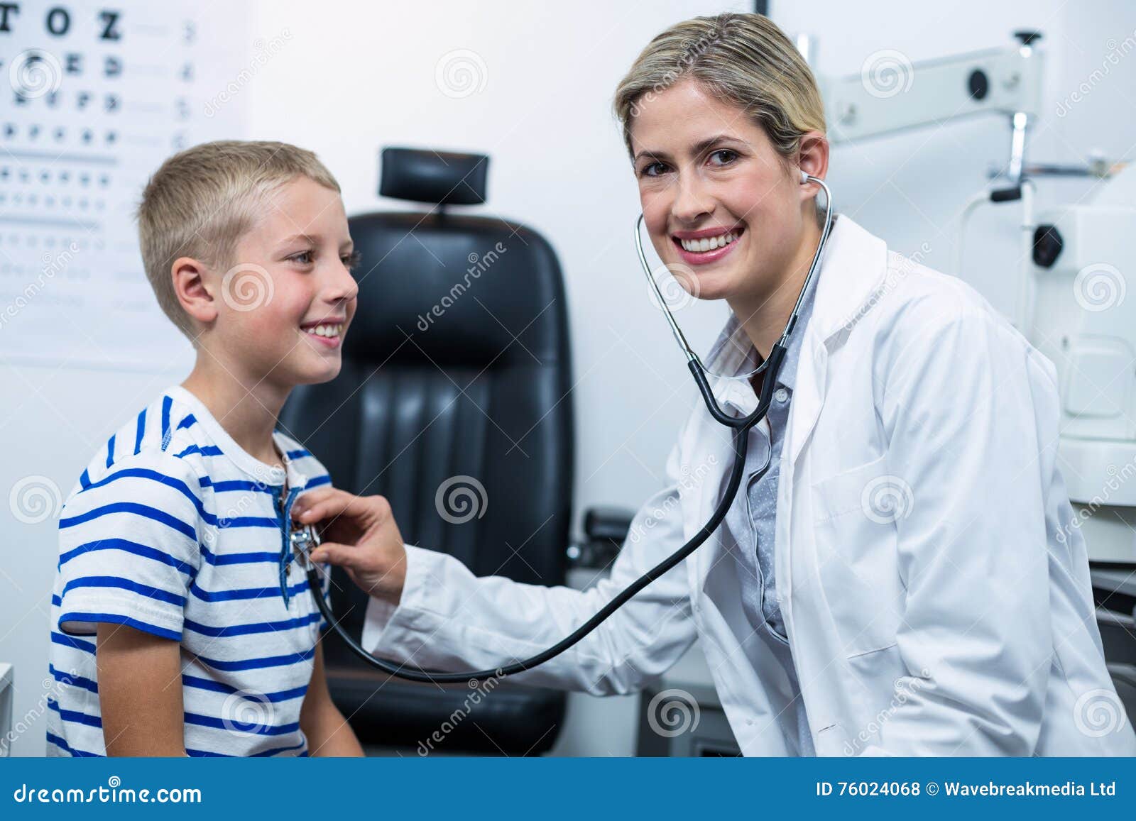 Female Optometrist Examining Young Patient with a Stethoscope Stock ... Female Optometrist Examining Young Patient with a Stethoscope Stock ...