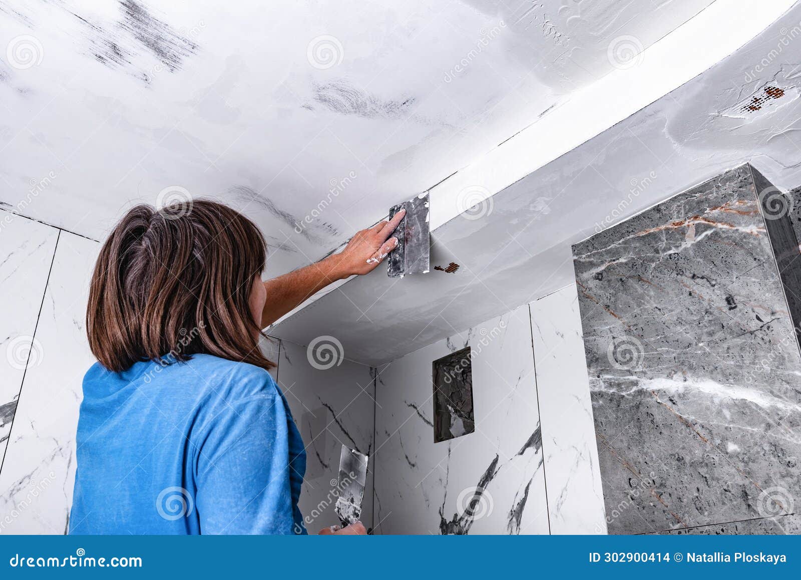 Female Painter Applying Putty To Ceiling. Stock Photo - Image of ...