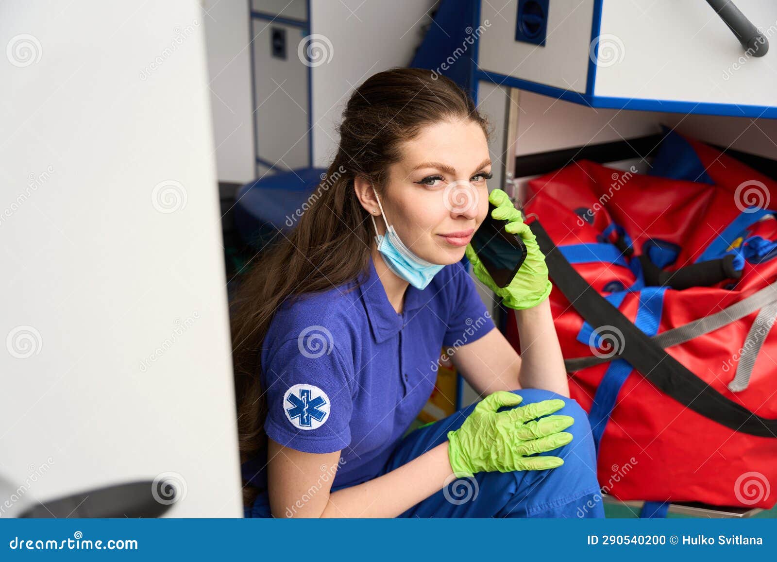Female Paramedic Communicates on a Mobile Phone Stock Photo - Image of ...