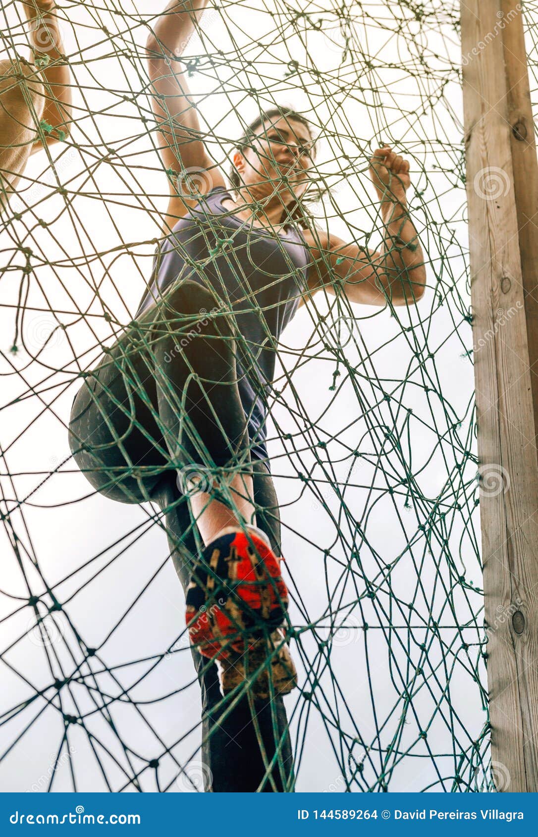 Participant in Obstacle Course Climbing Net Stock Photo - Image of ...