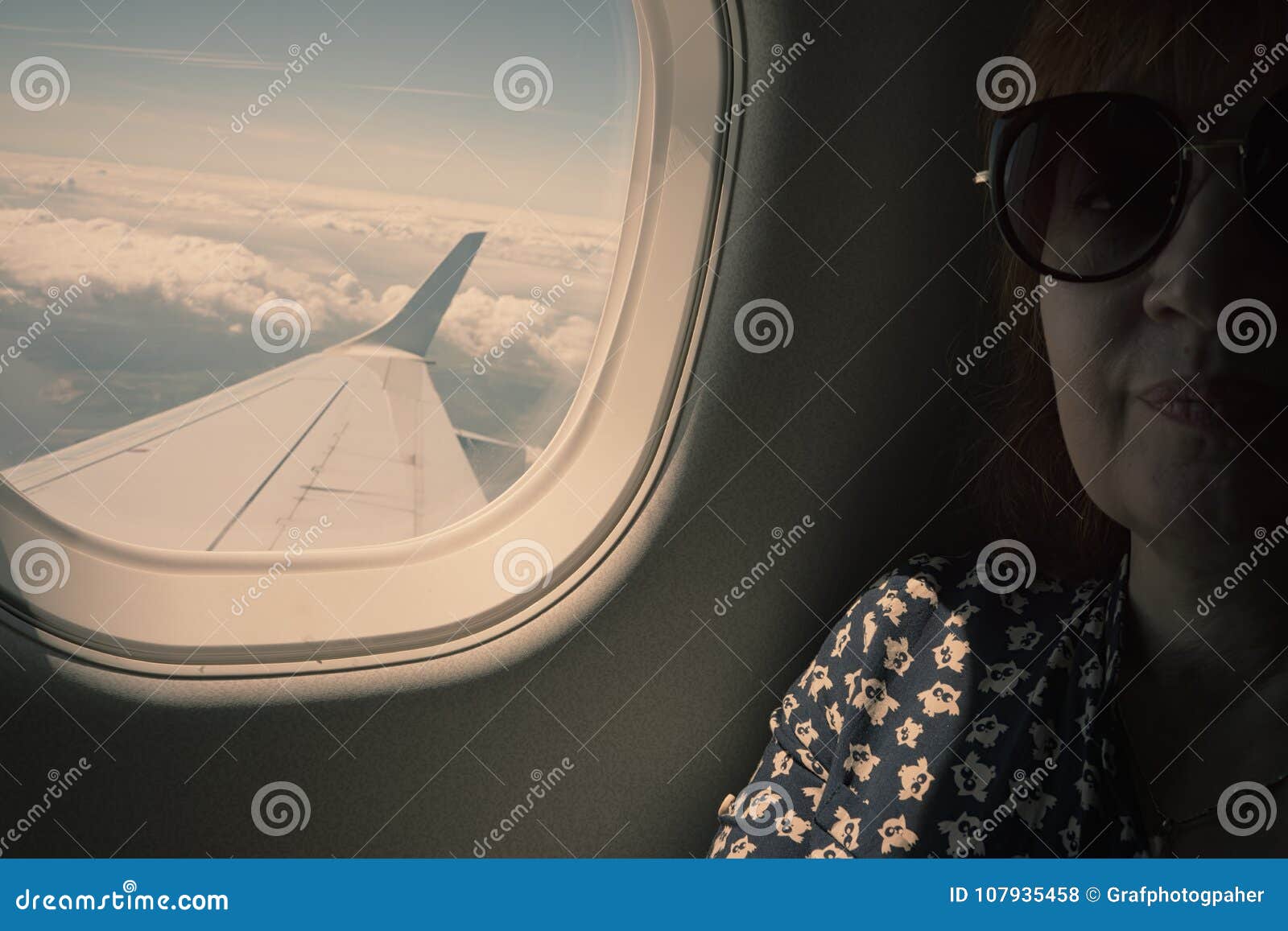 Female Passenger Is Sitting By The Airplane Window. The Wing Of Stock ...