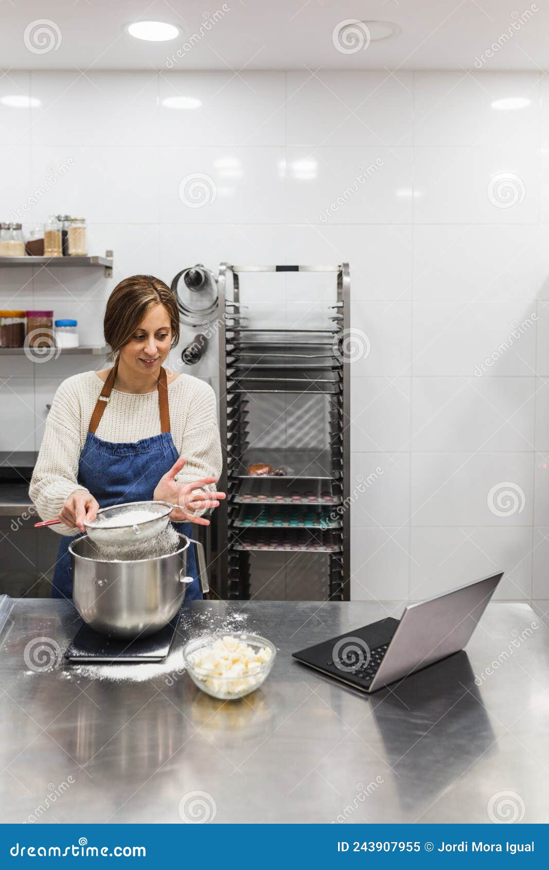 Female Pastry Chef Using a Laptop Computer while Making Tasty Baking in ...