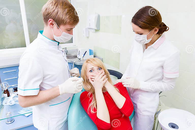 Female Patient In Dentist Office Afraid Of Doctor Procedure Stock