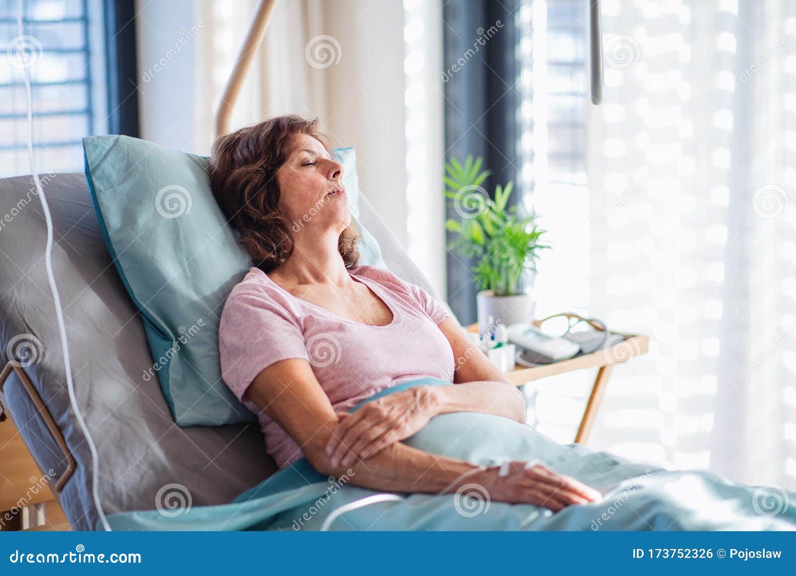 A Female Patient with IV Drip Lying in Bed in Hospital Room. Stock ... A Female Patient with IV Drip Lying in Bed in Hospital Room. Stock ...
