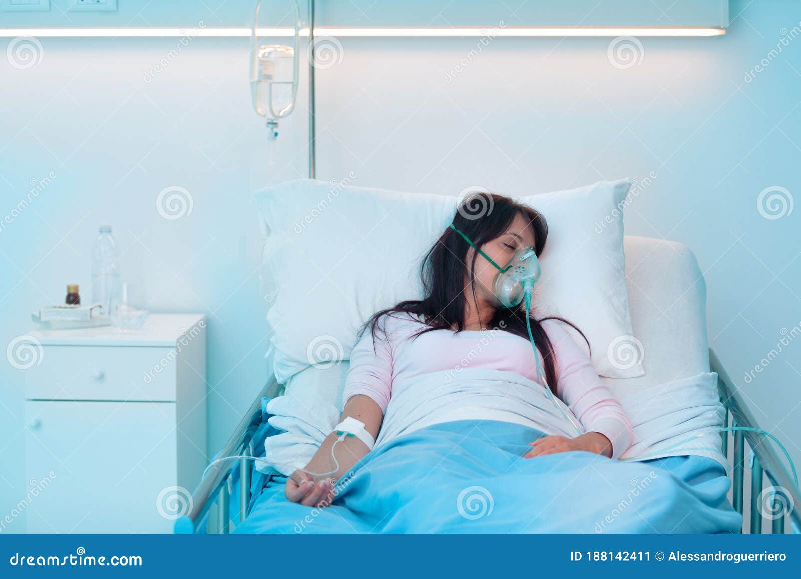 Female Patient With Oxygen Mask In A Hospital Bed At Night Stock Image