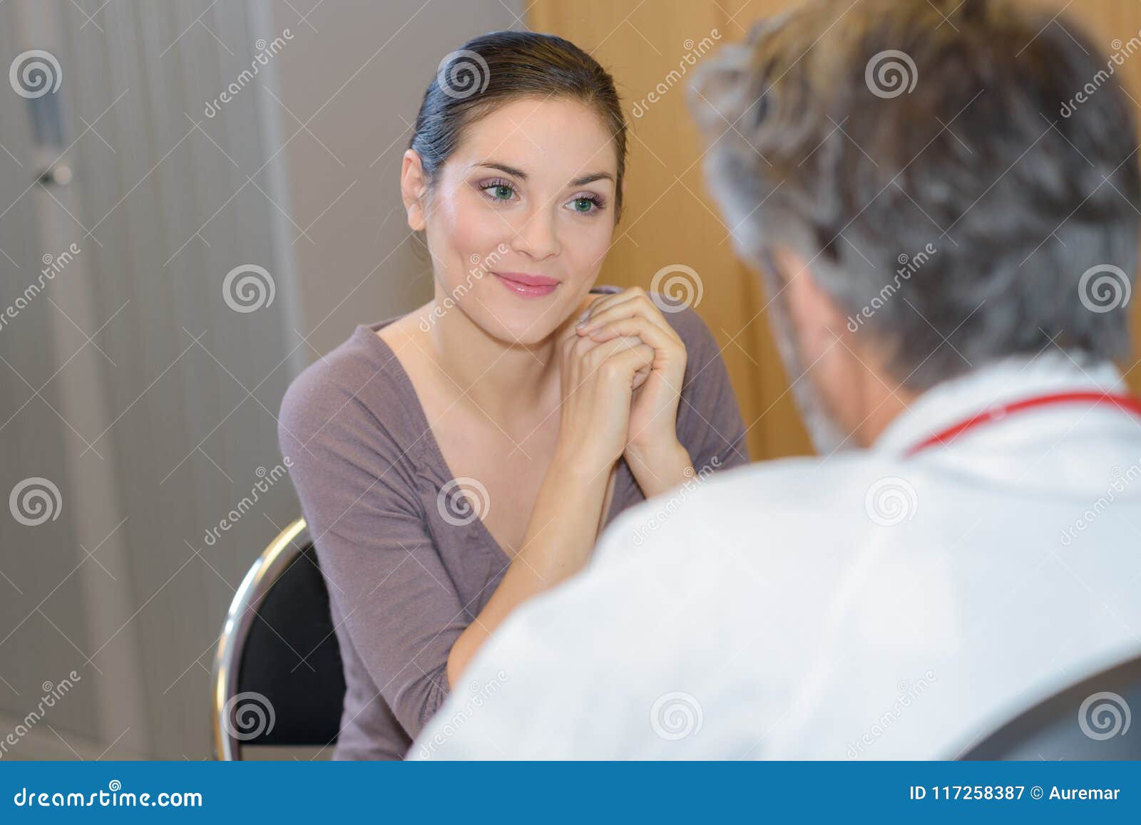 Female Patient Smiling at Doctor Stock Image - Image of clinic, person ...