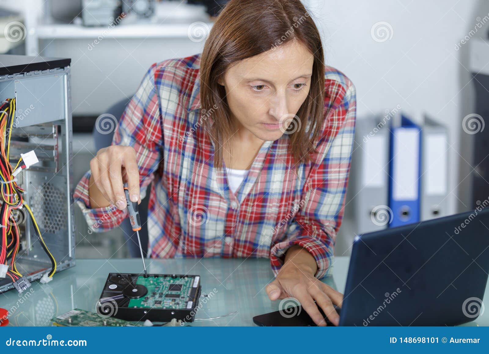 Female Pc Technician Looking at Tutorial for Fixing Computer Stock ...