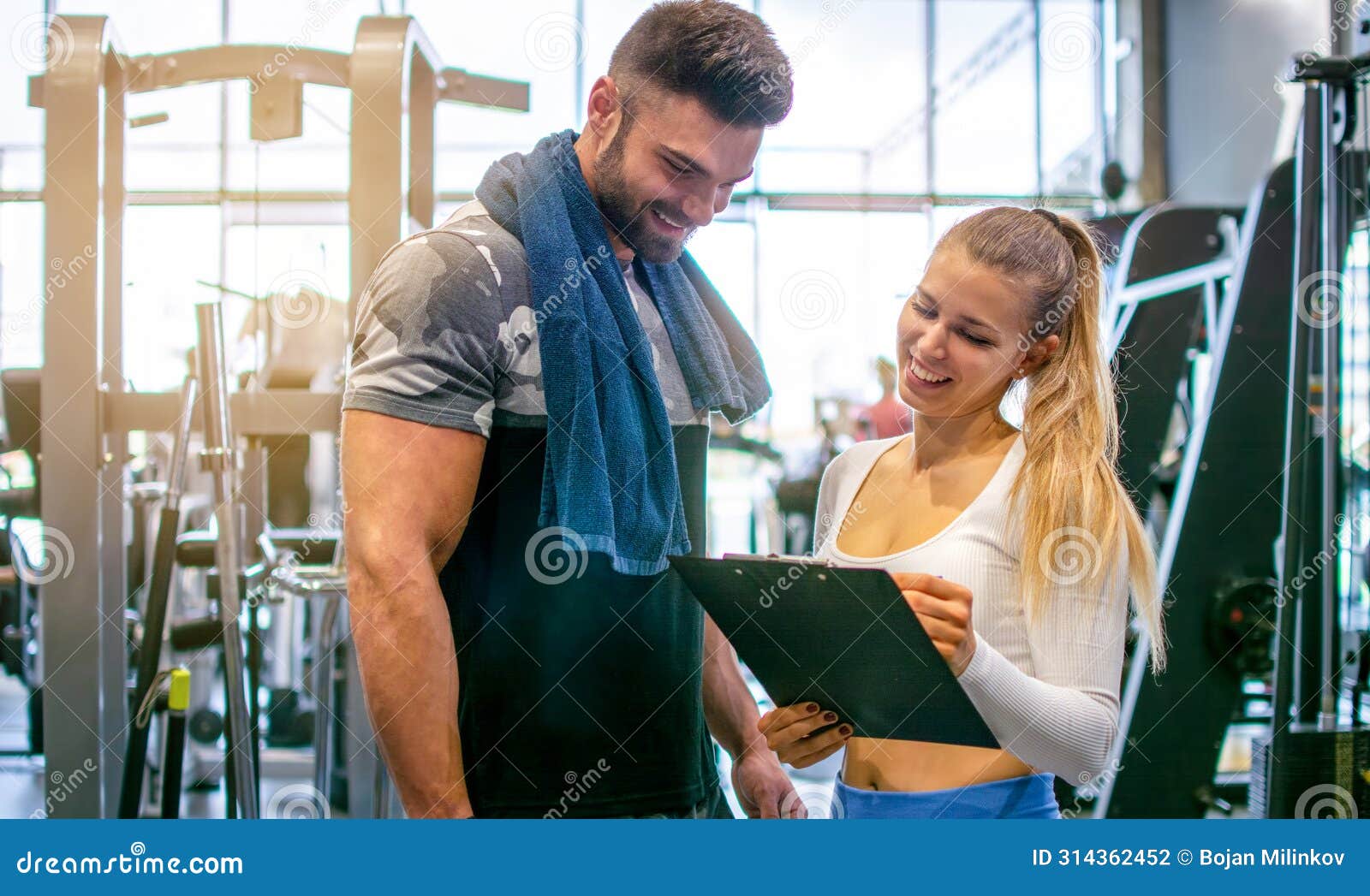 Female Personal Trainer Talking about Exercise Progress with Male ...