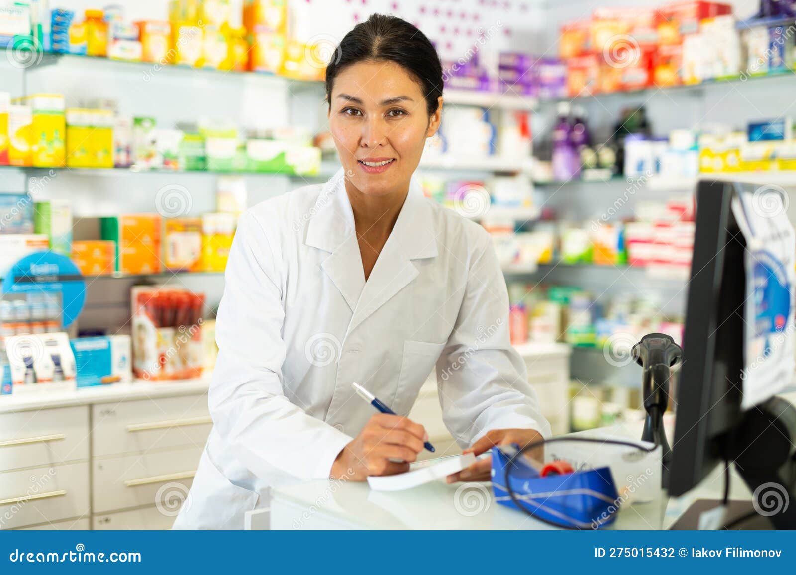 Female Pharmacist Working in Pharmacy, Using Computer Screen Stock ...