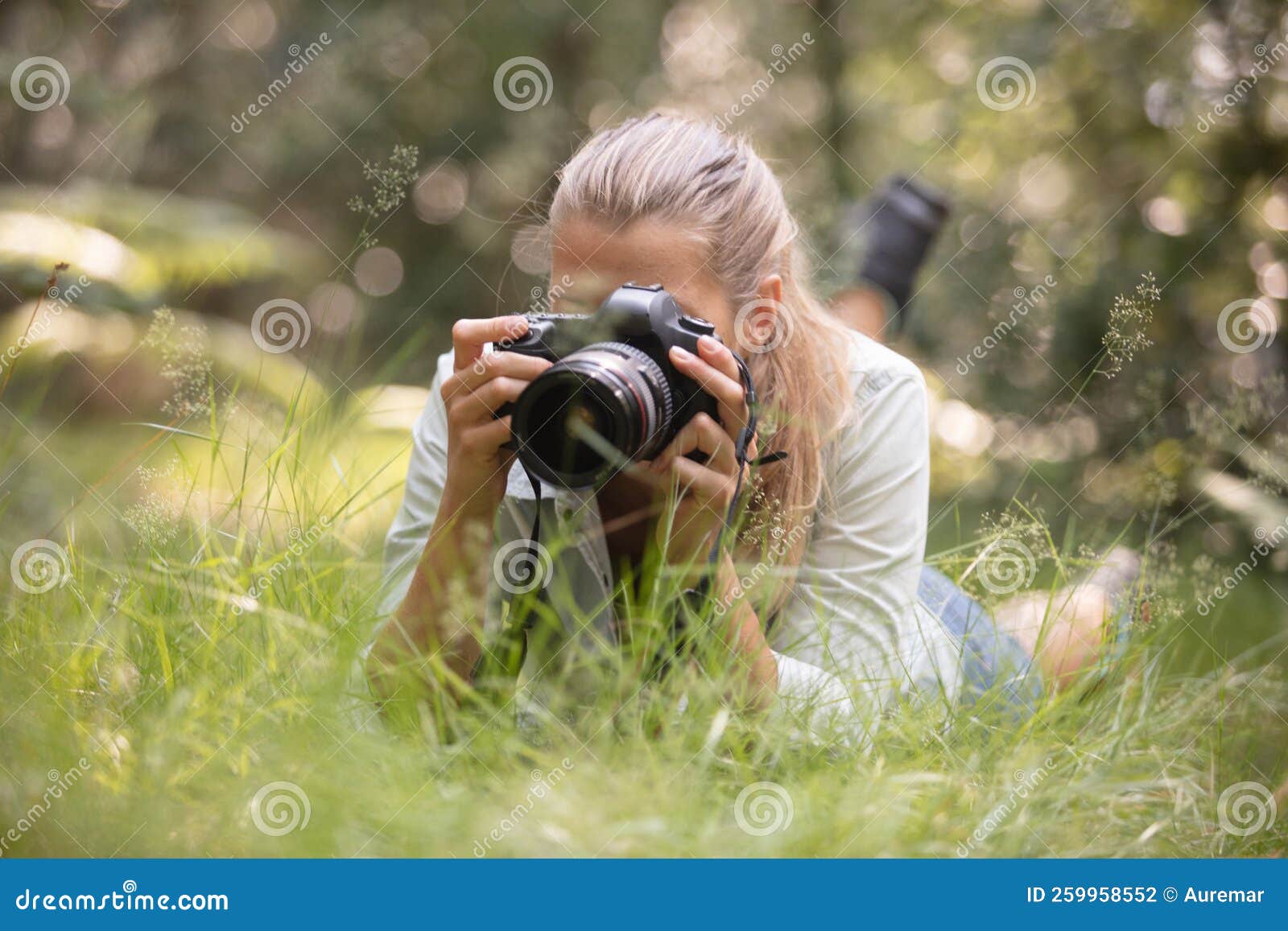 Female Photographer Laying on Grass Stock Photo - Image of sunny ...