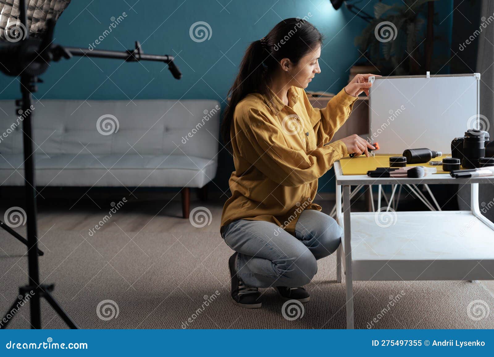 Female Photographer Preparing for the Shooting Laying Out Props on the ...