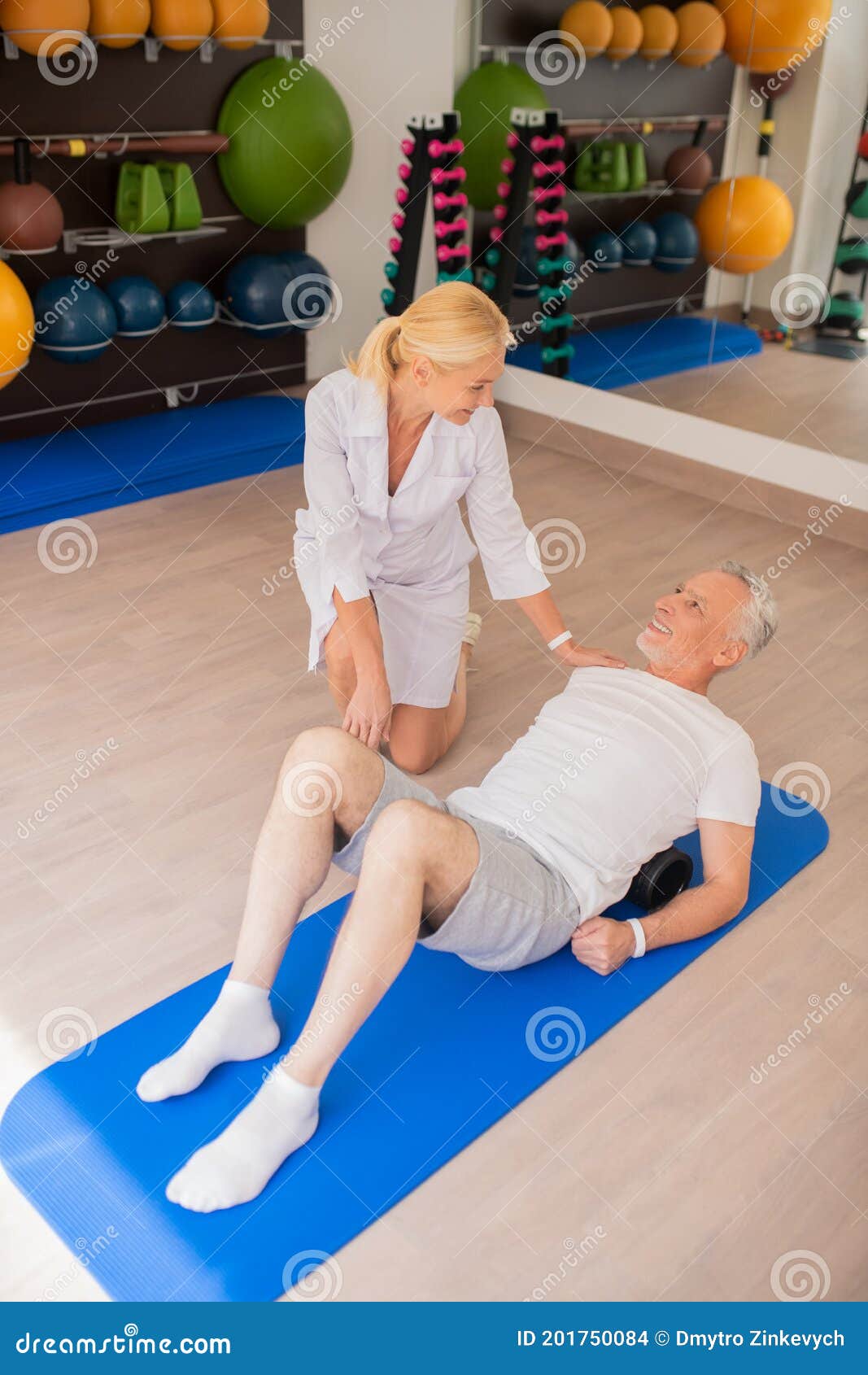 A Female Physical Therapist in Lab Coat Helping a Patient Stock Photo - Image of efforts ...