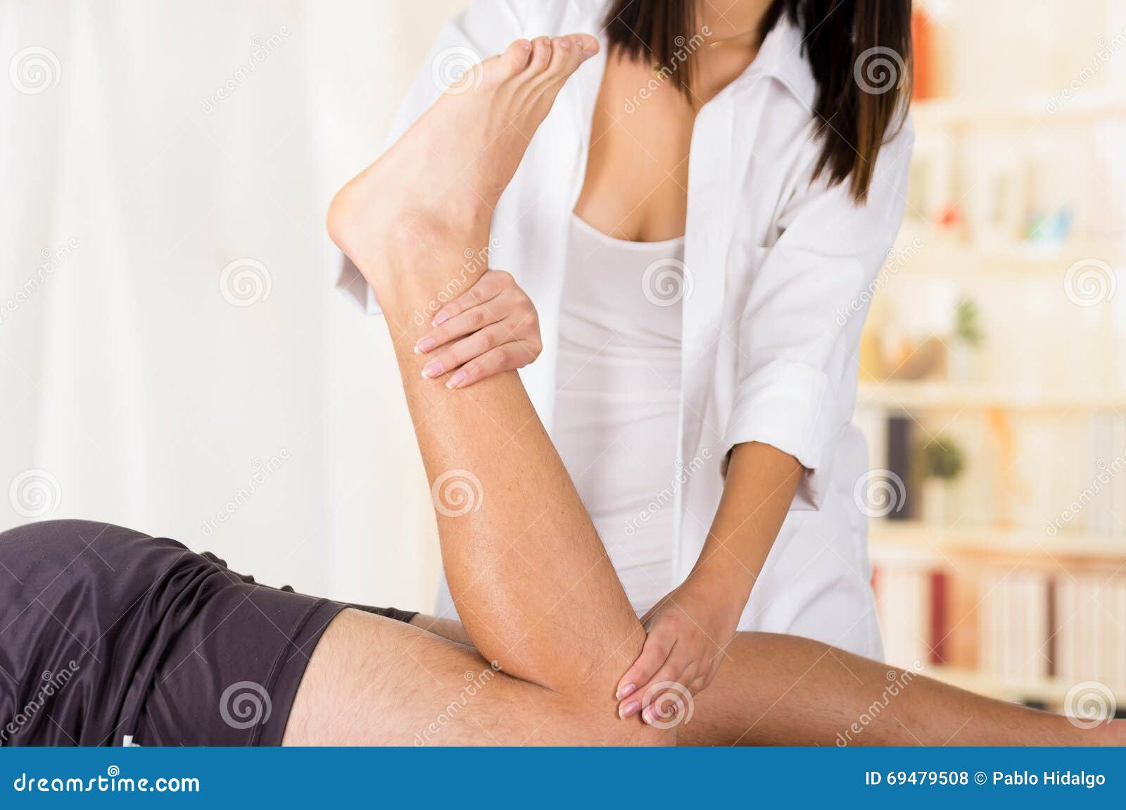 Female Physio Therapist Hands Working On Male Patients Legs Holding