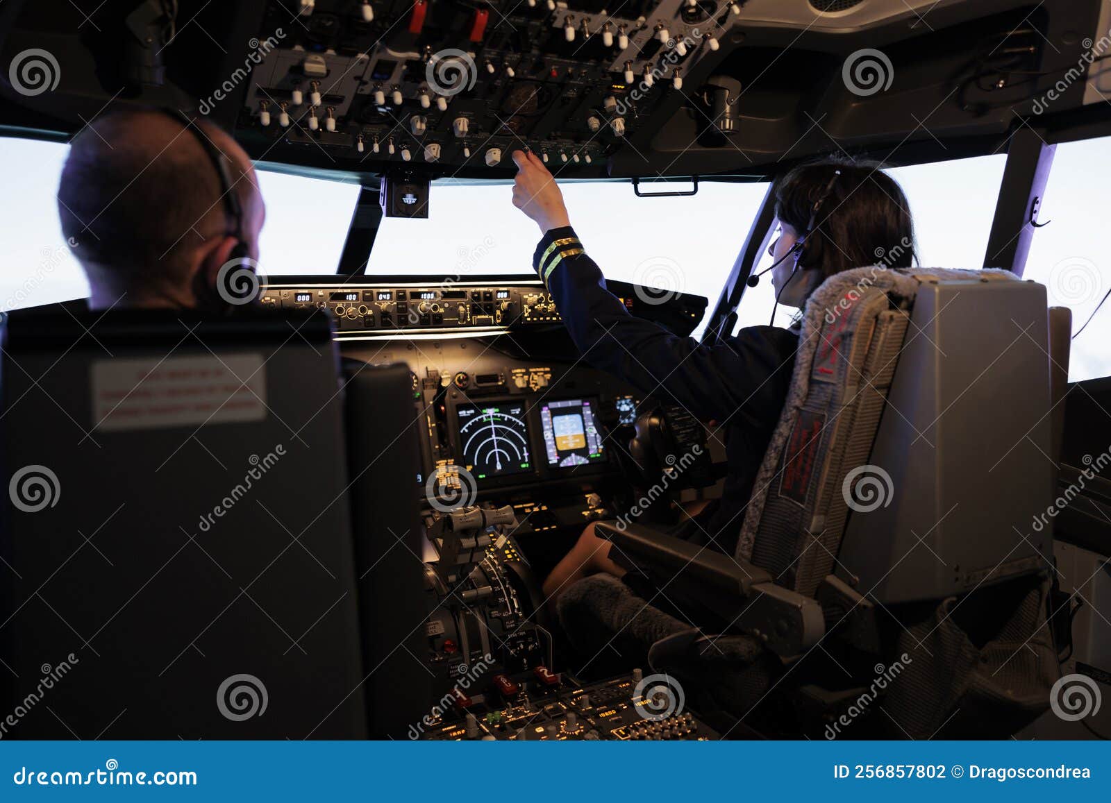 Female Pilot Assisting Captain To Takeoff and Fly Airplane Stock Photo ...