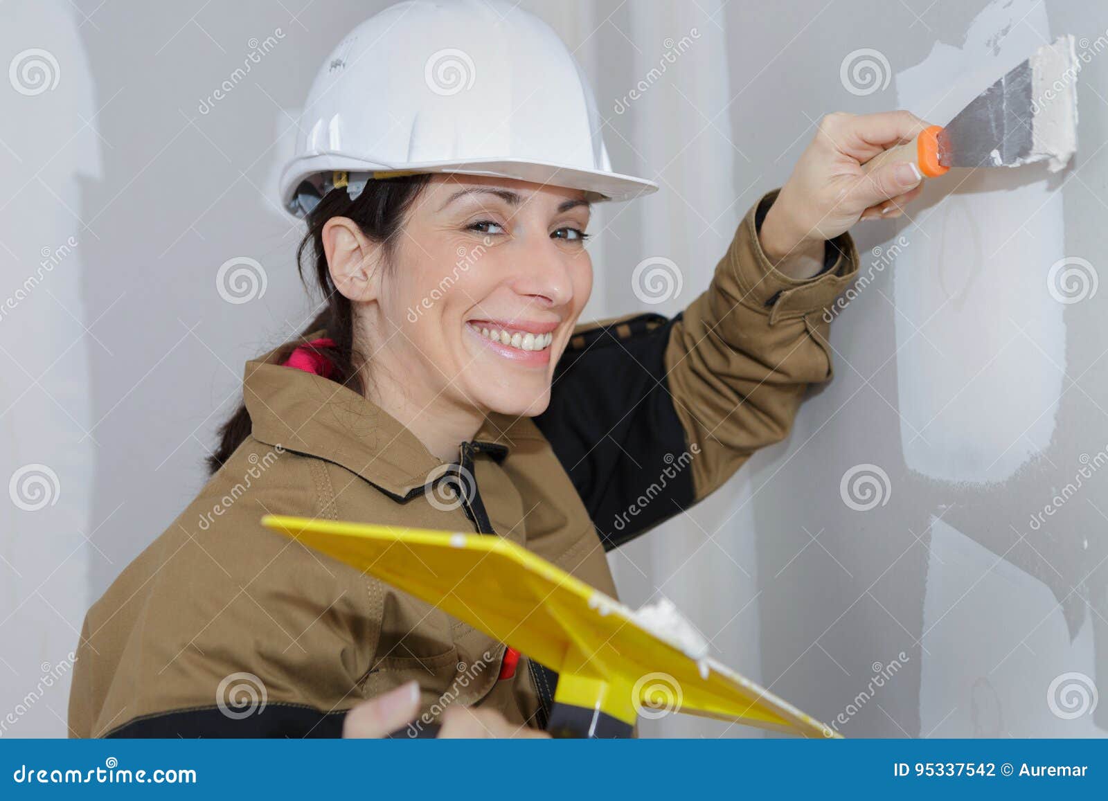 Female Plasterer Doing Wall Renovation with Spatula and Plaster Stock ...