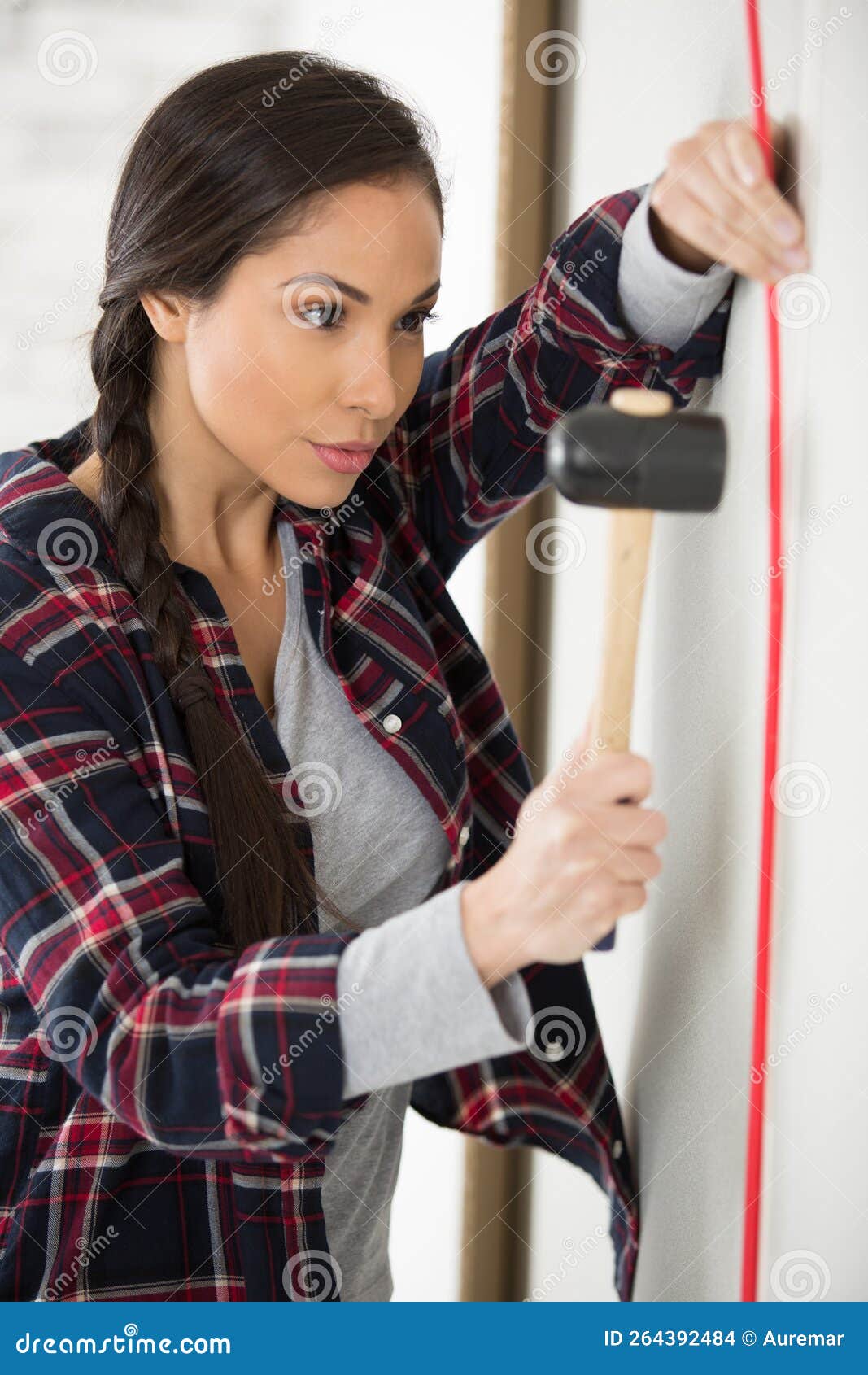Female Plasterer Tapping Tube Against Dry Wall Stock Photo - Image of ...