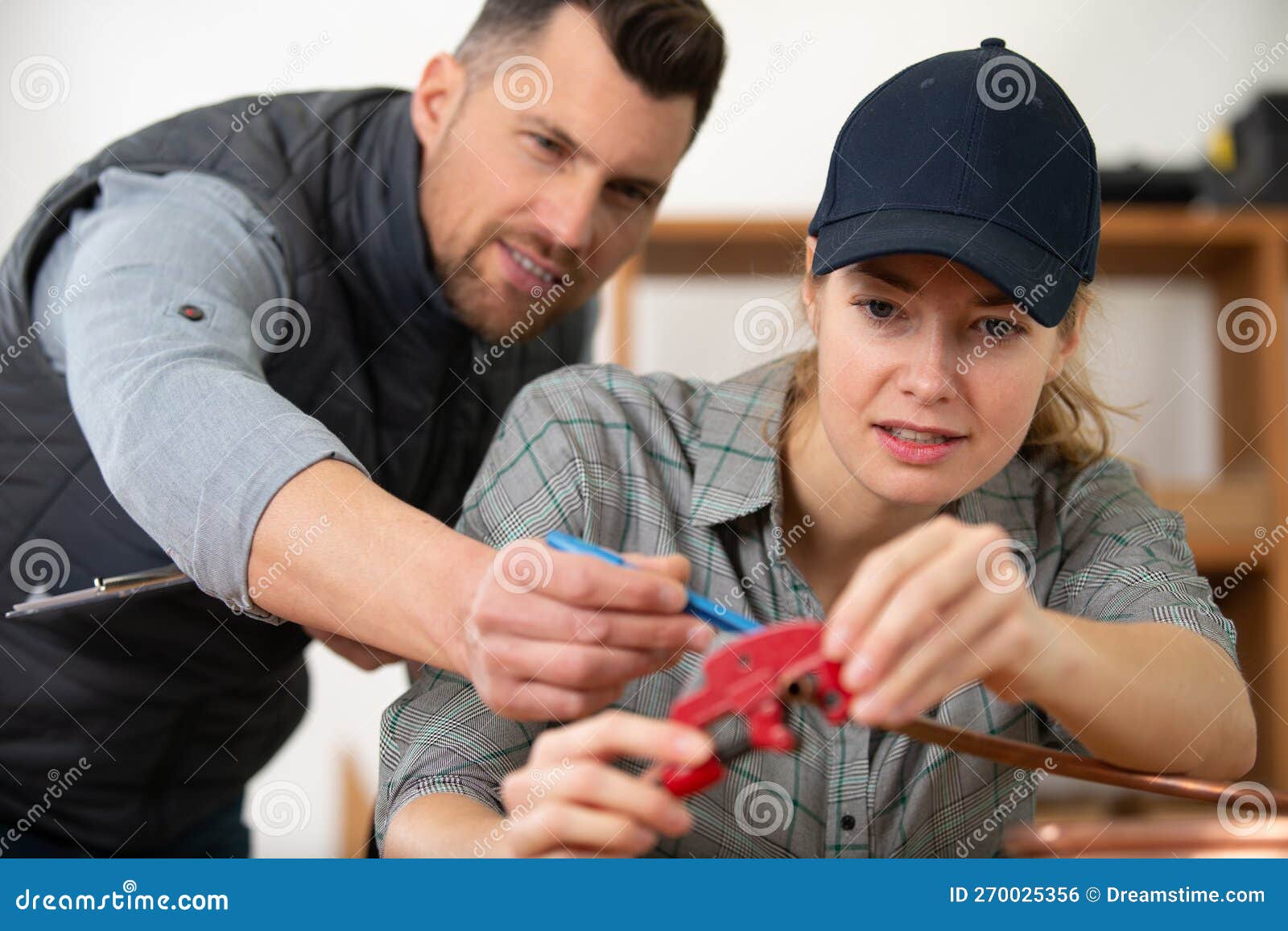 Female Plumber Apprentice Working with Cooper Pipes Stock Photo - Image ...