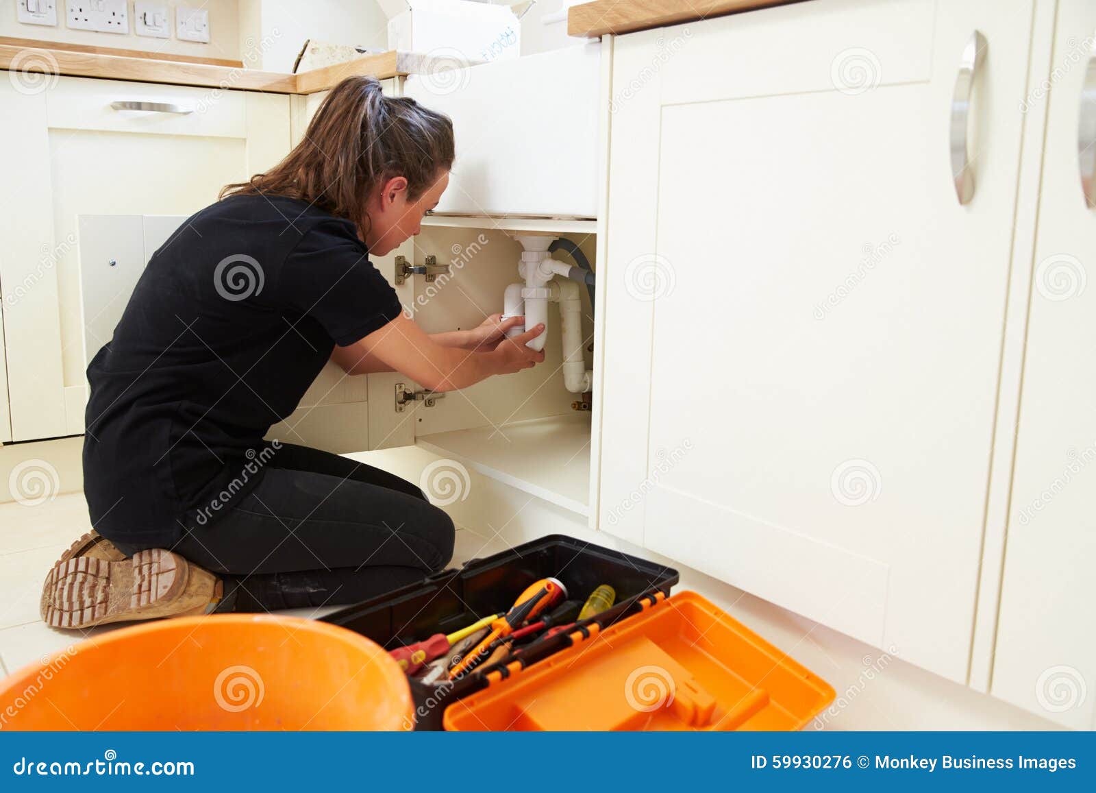 Female Plumber Fixing a Kitchen Sink Stock Photo - Image of pipe ...