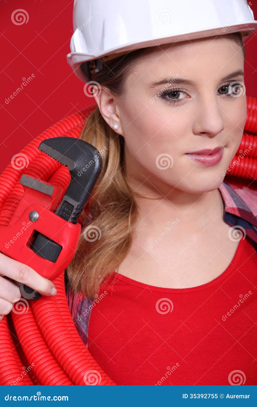 Female plumber in red stock image. Image of pliers, builder - 35392755