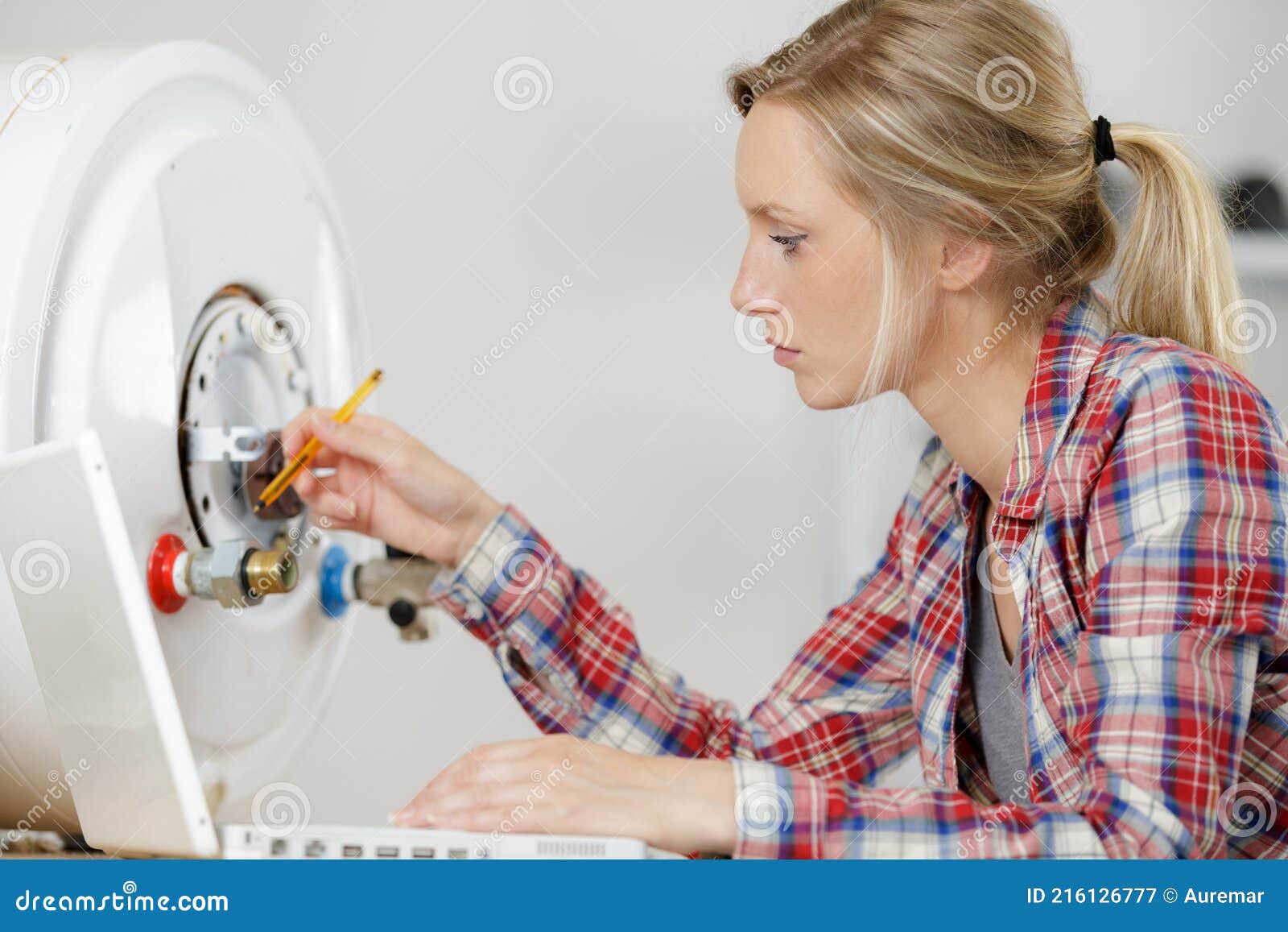 Female Plumber Using Laptop while Working on Boiler Stock Image - Image ...