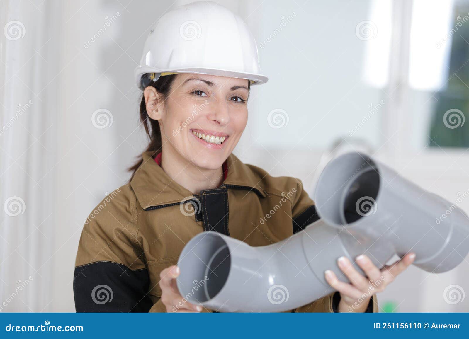 Female plumber at work stock photo. Image of arms, isolation - 261156110