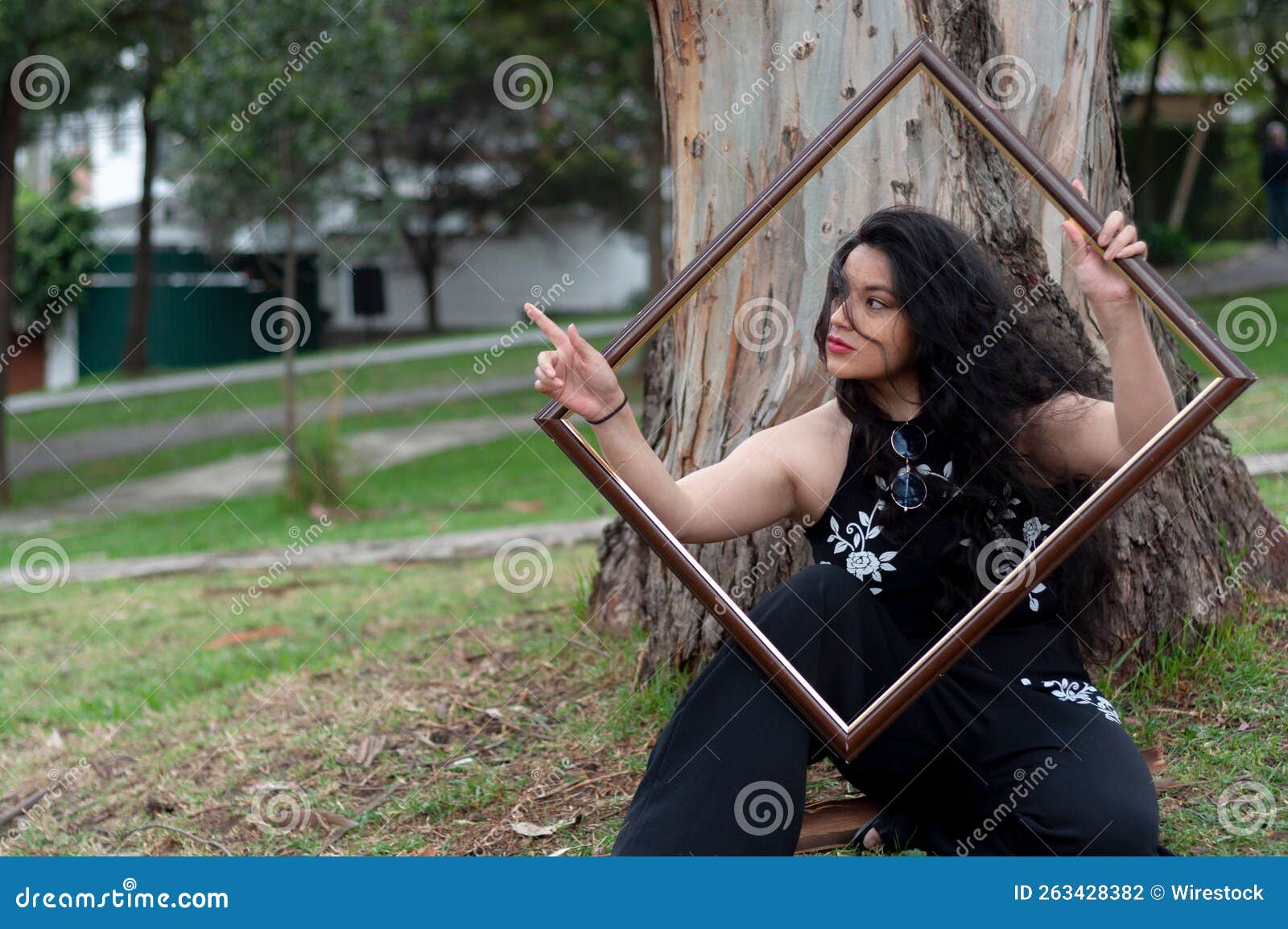 Female Poking Head Out of Picture Frame in Park Stock Photo - Image of ...