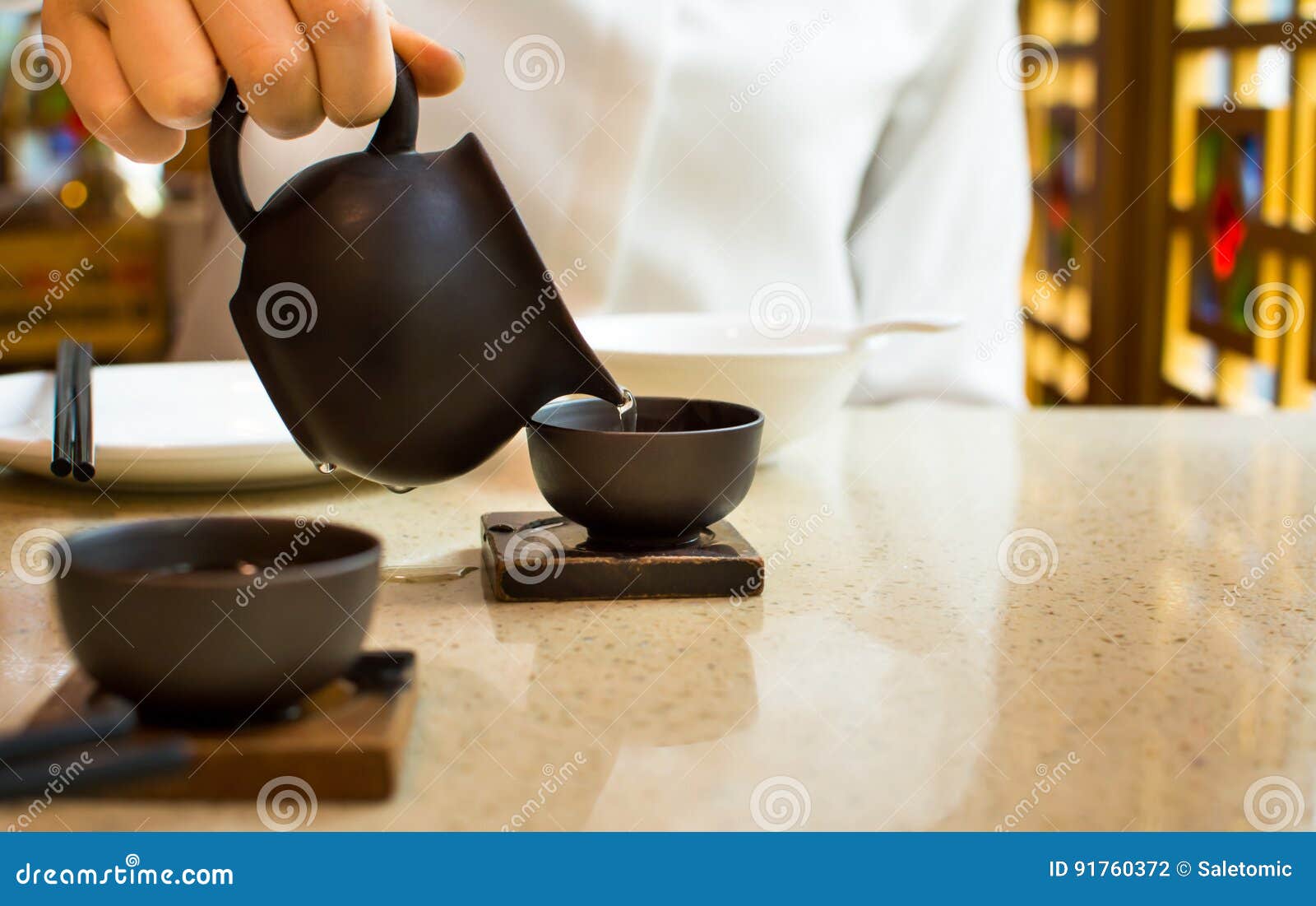 Female Pouring Tea into Ceramic Teacup Stock Photo - Image of female ...