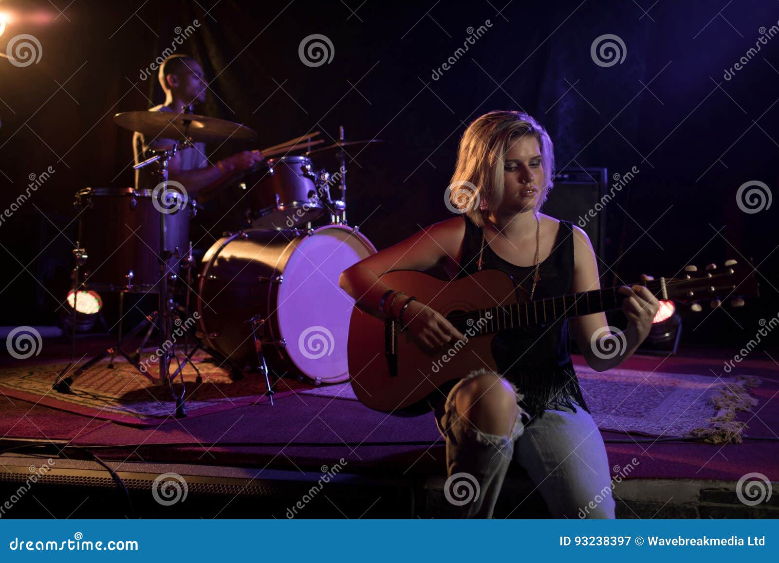 Female Practicing Guitar while Sitting on Stage Stock Image - Image of ...
