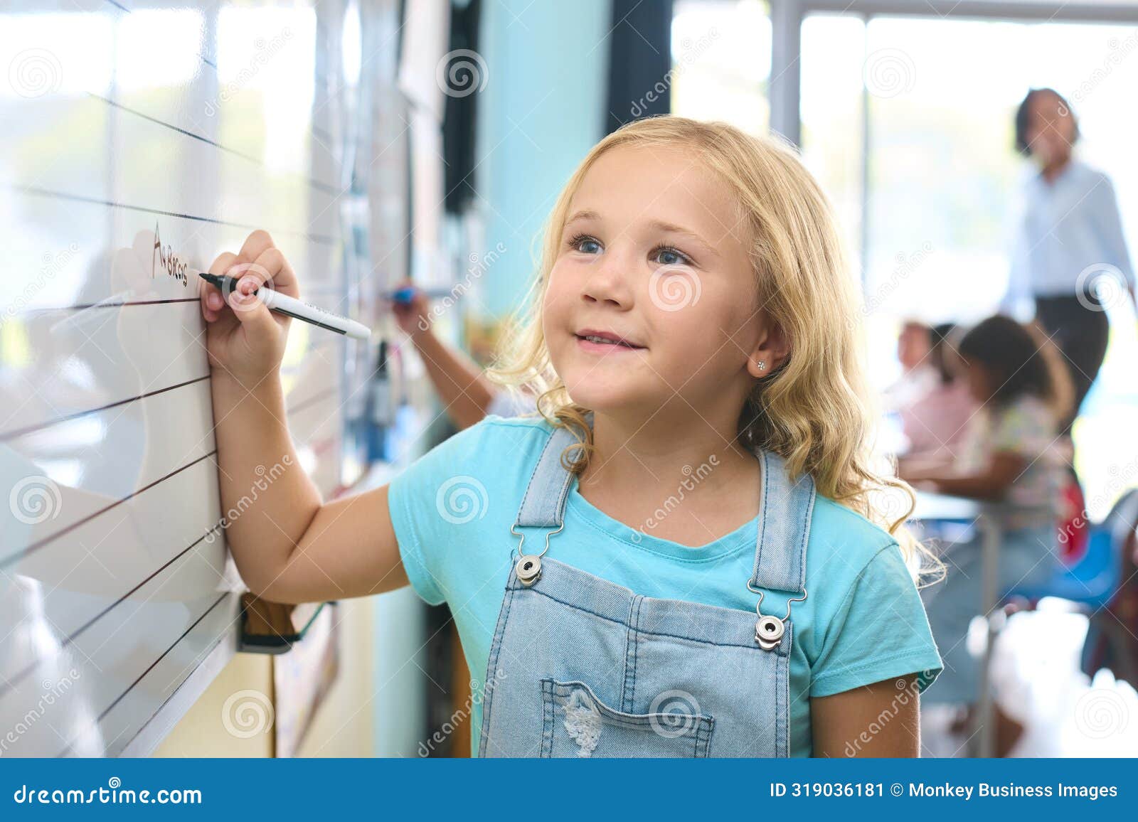 Female Primary or Elementary School Student Writing on Whiteboard in ...