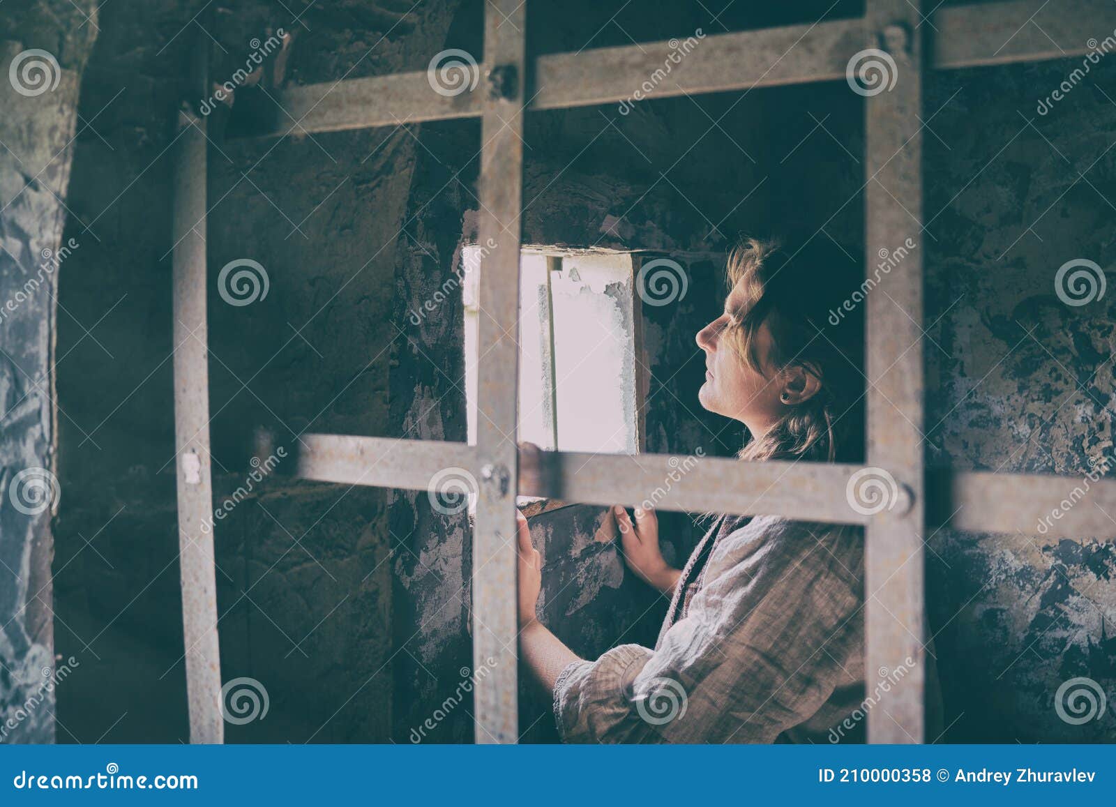 A Female Prisoner Looks at the Sunlight through a Small Window in a ...